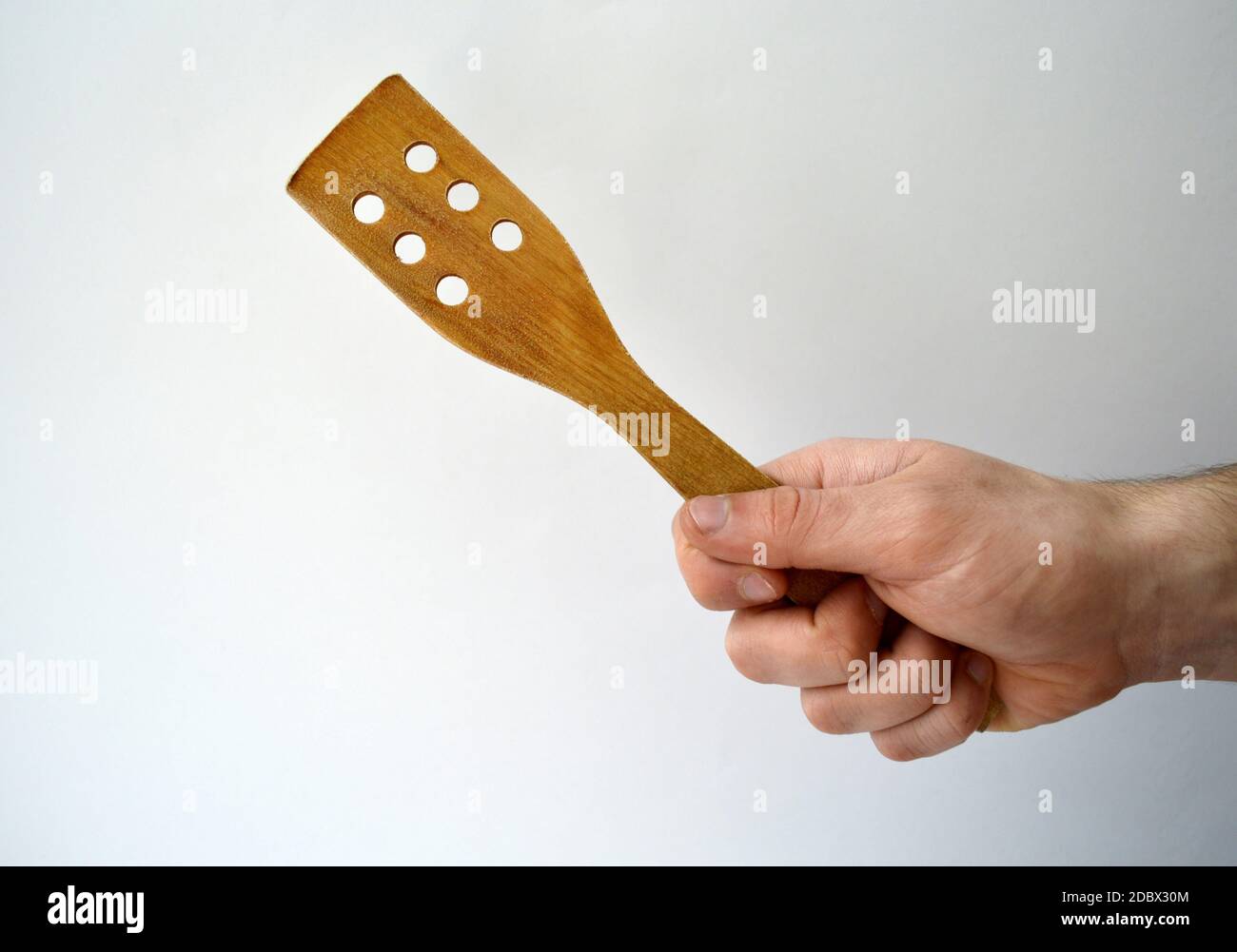 Mans hand wooden spatula hi-res stock photography and images - Alamy