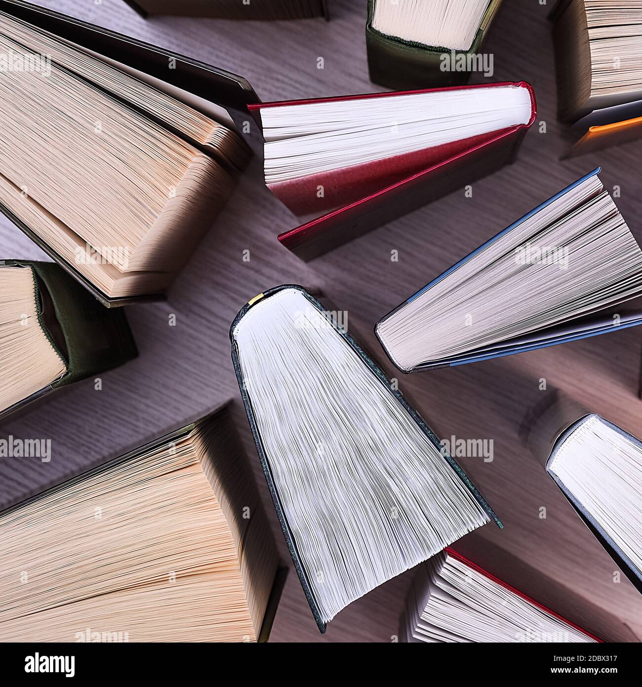 Books on the table, top view. In books, the sheets are spread out in ...