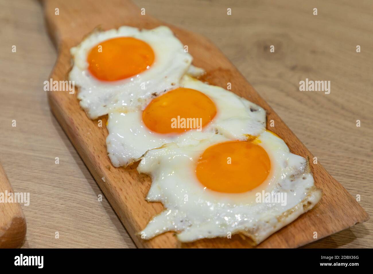 Fried Eggs Sunny Side Up Served at Board Stock Photo - Alamy