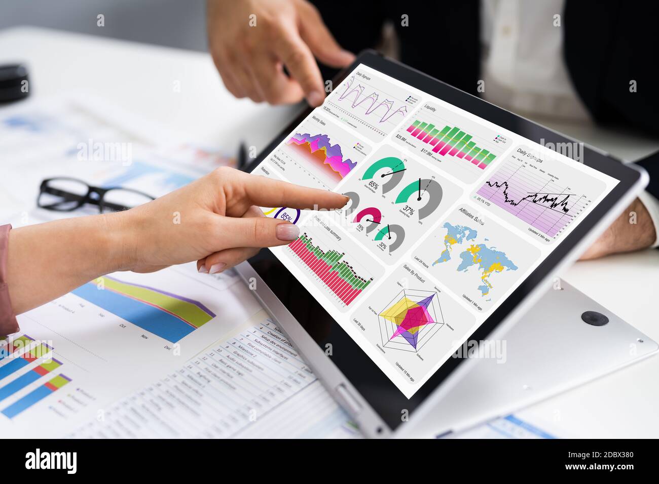 Financial Analyst Using Convertible Laptop Screen With Graphs Stock ...