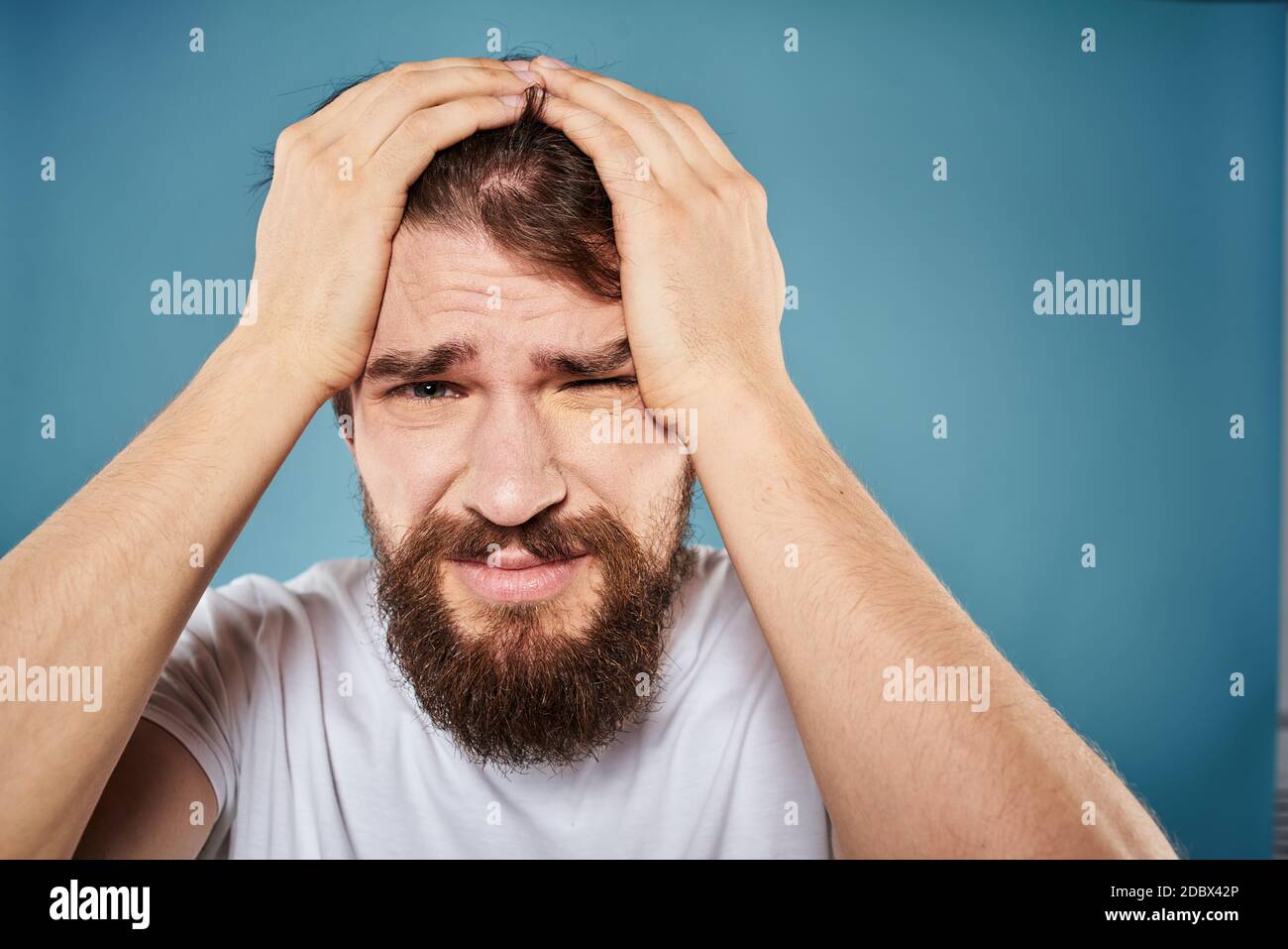Bearded man displeased facial expression emotions close-up blue ...