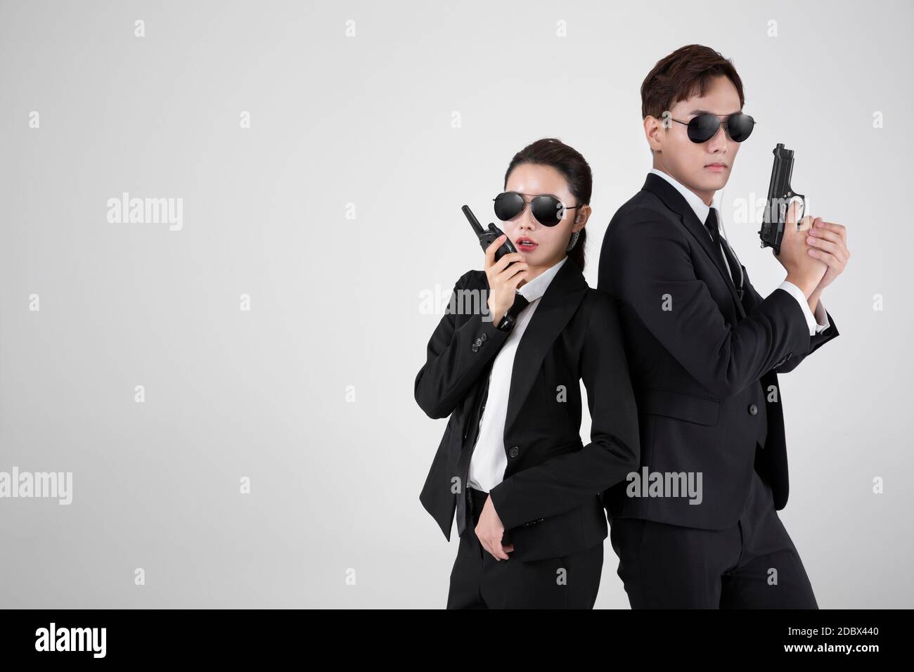 Asian male and female two security guards 123 Stock Photo - Alamy