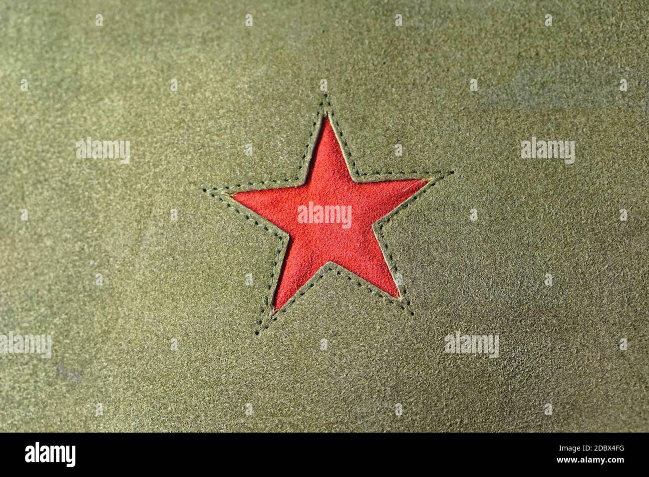 Red star symbol at green textile Stock Photo - Alamy