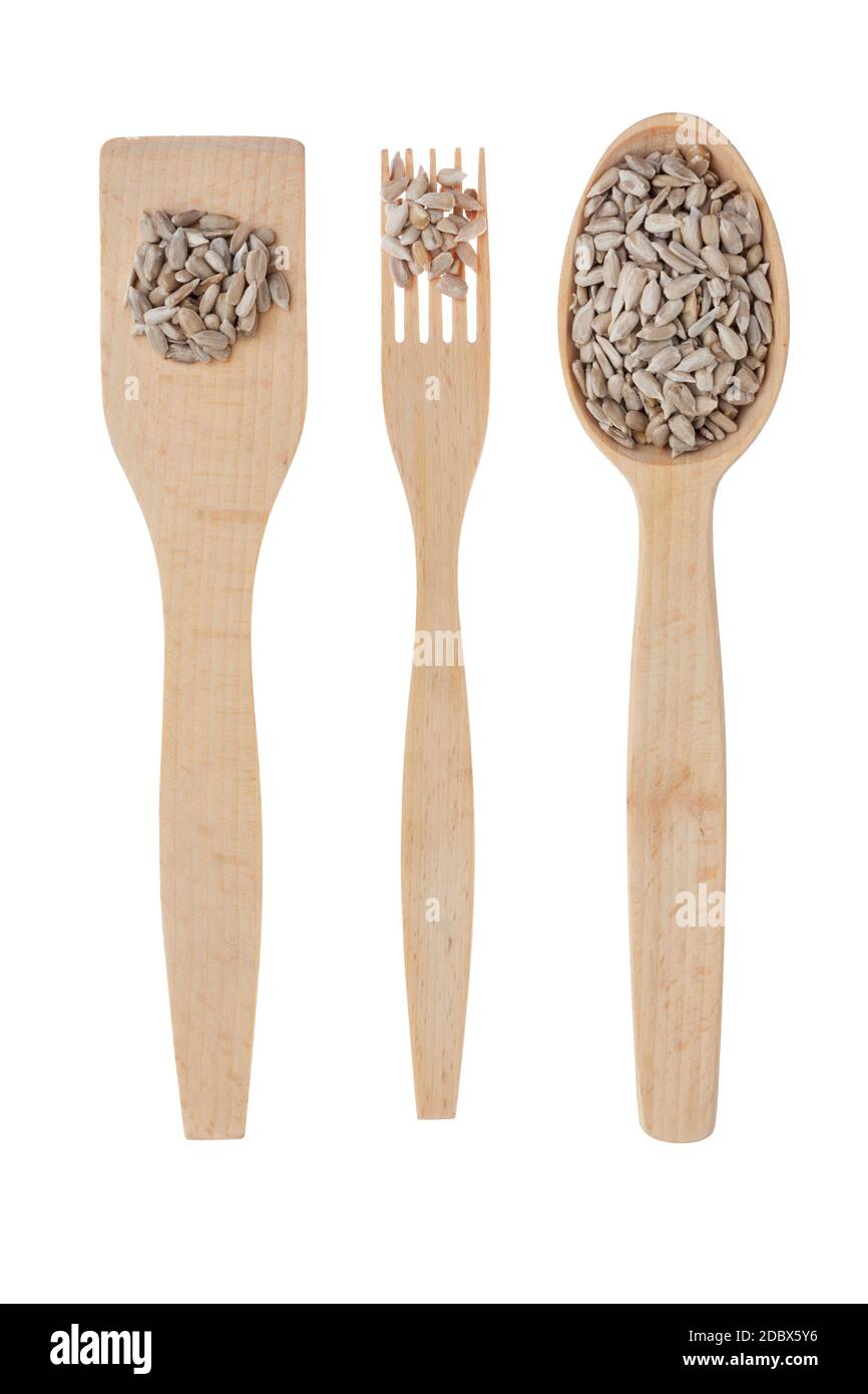 Wooden spoon, fork, paddle with sunflower seed, isolated on white ...