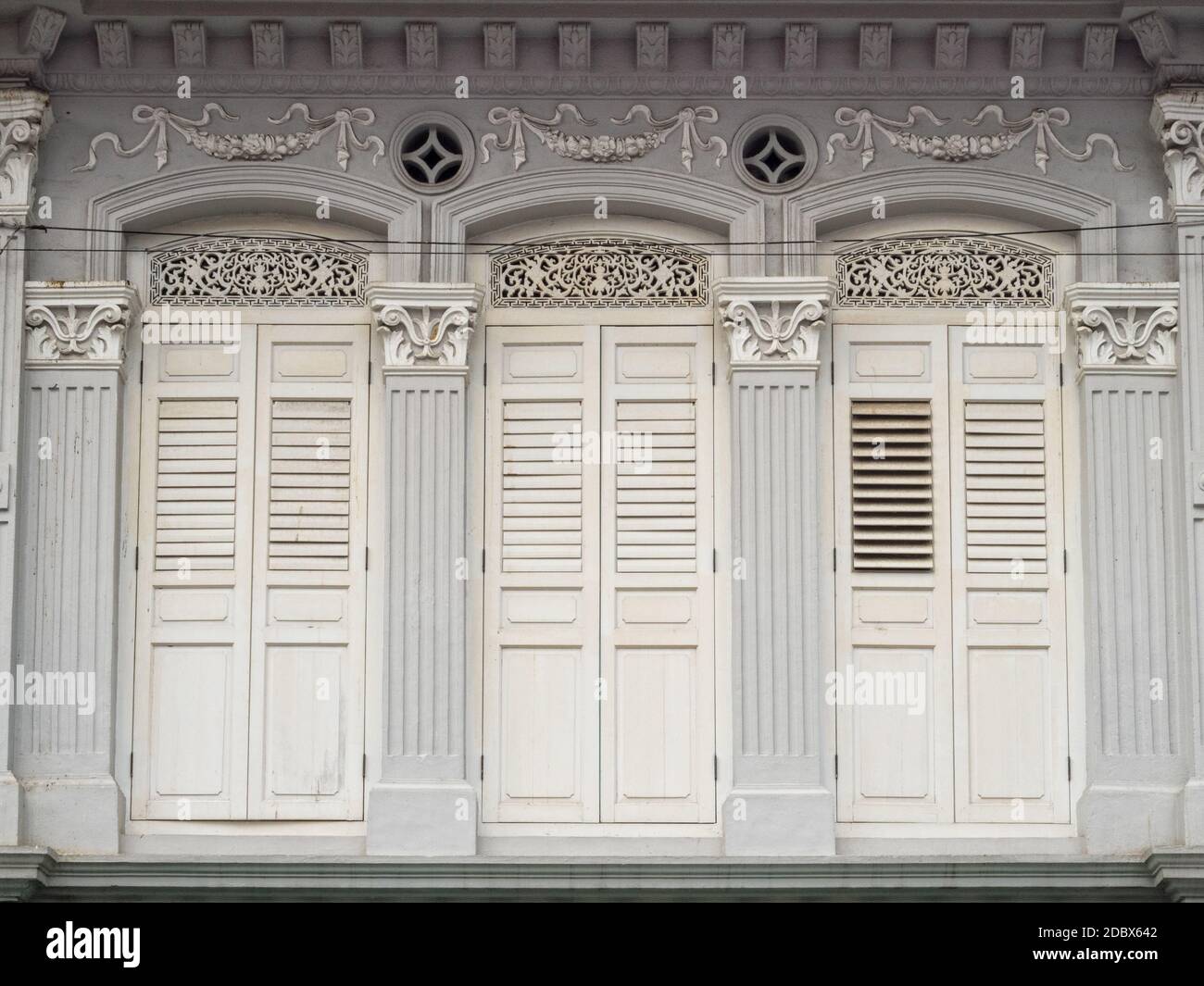 Traditional white shutters of a shophouse in Little India - Singapore ...