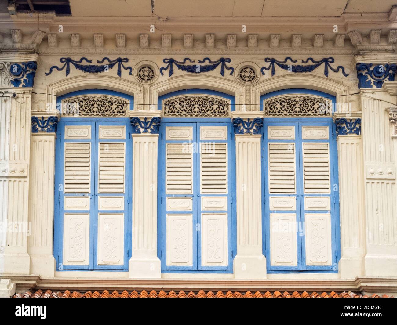 Closed shutters of a traditional shophouse in Little India - Singapore ...