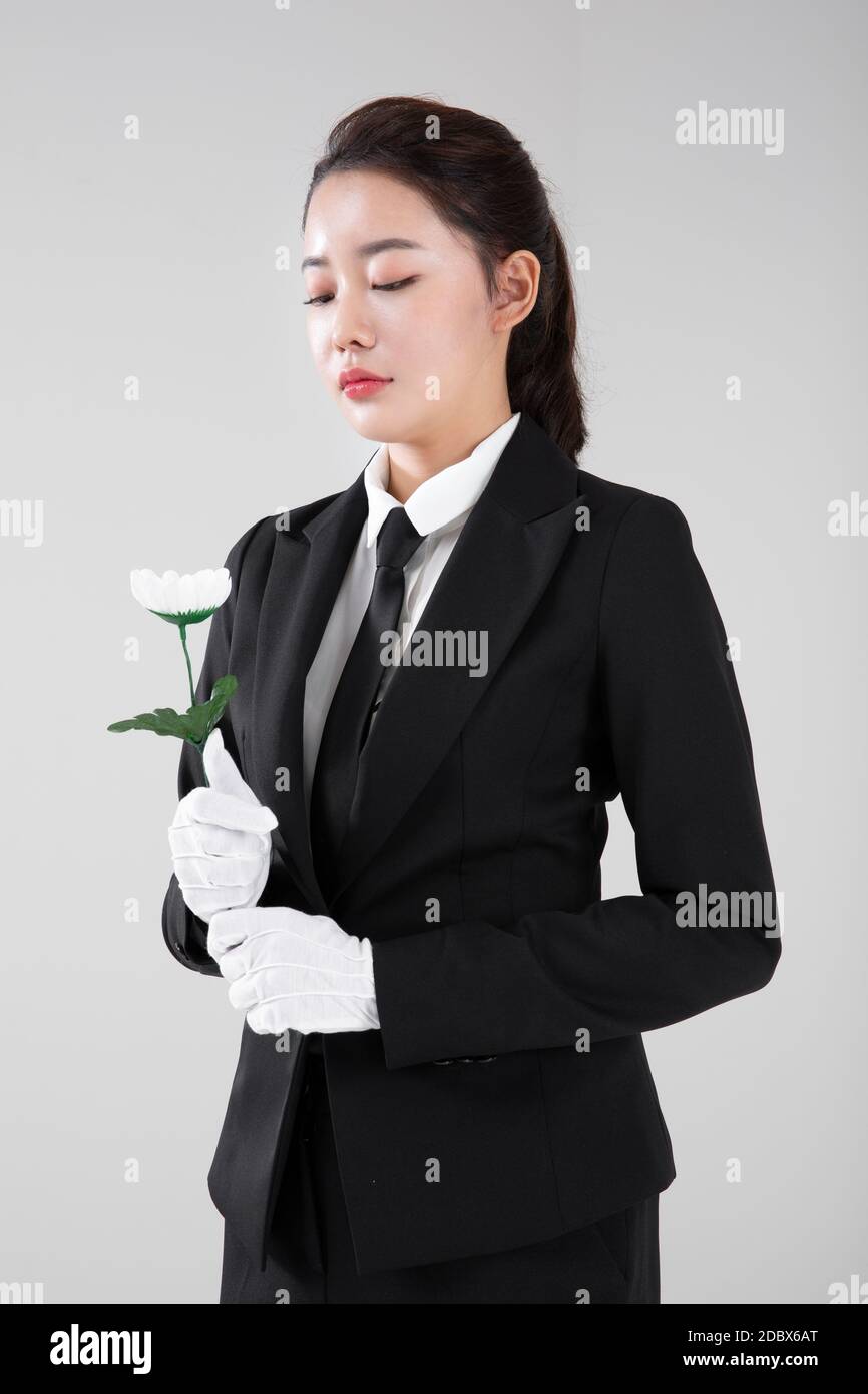 Cremation, people and mourning concept with flowers 020 Stock Photo - Alamy