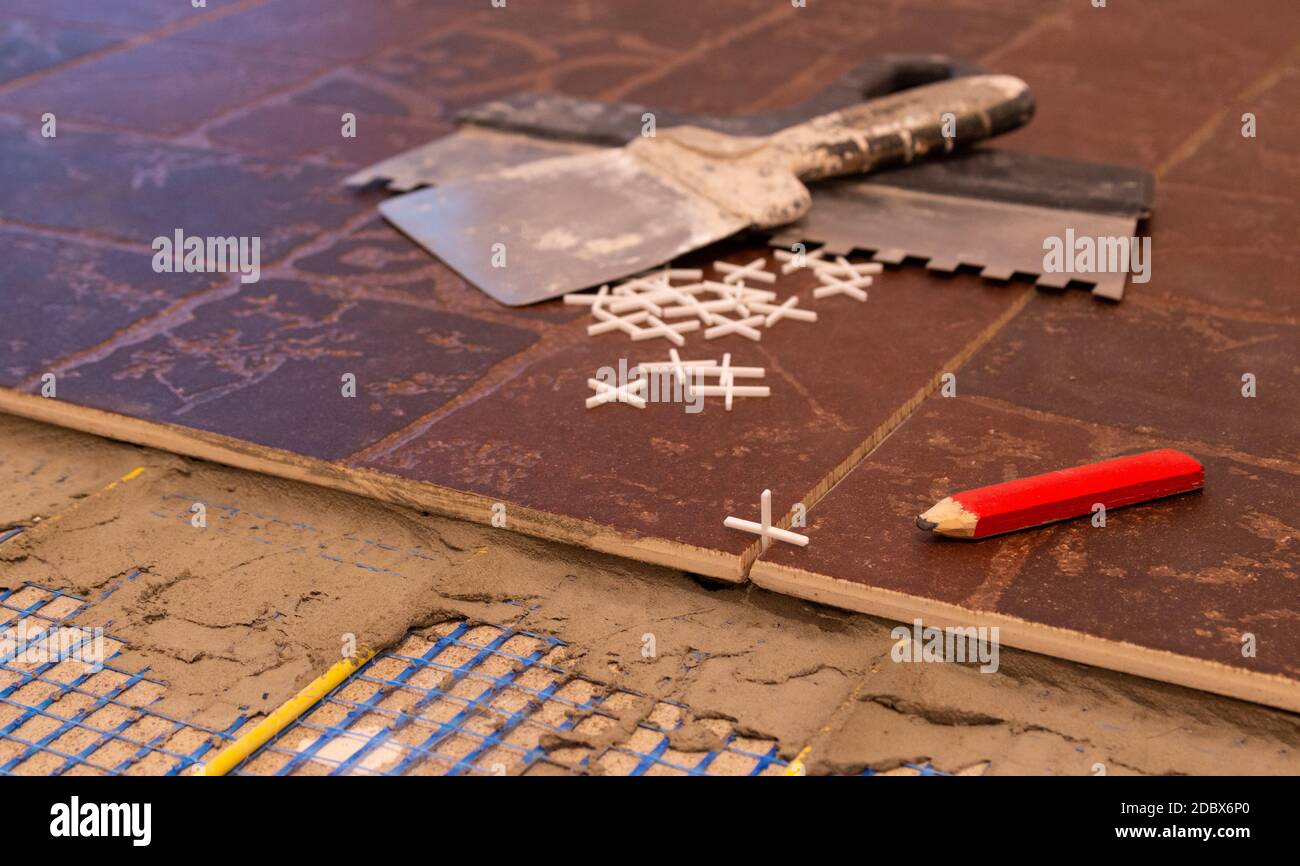 ceramic tiles for warm floors, trowel trowel pencil Stock Photo - Alamy