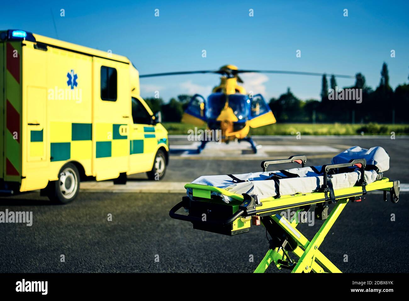 Stretcher against ambulance car and helicopter of emergency medical ...