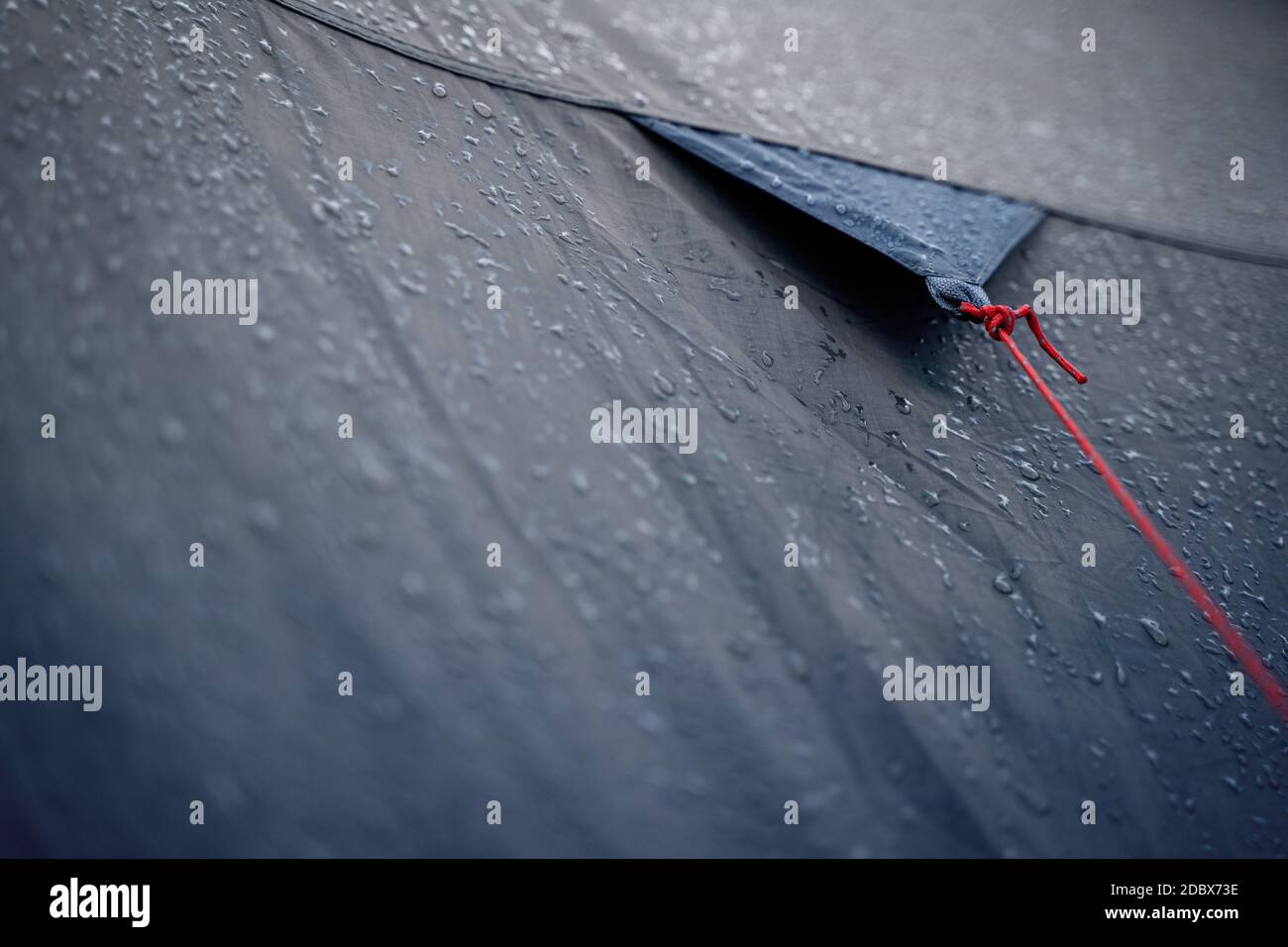 closeup detail perspective view of anchoring red rope on dark blue ...