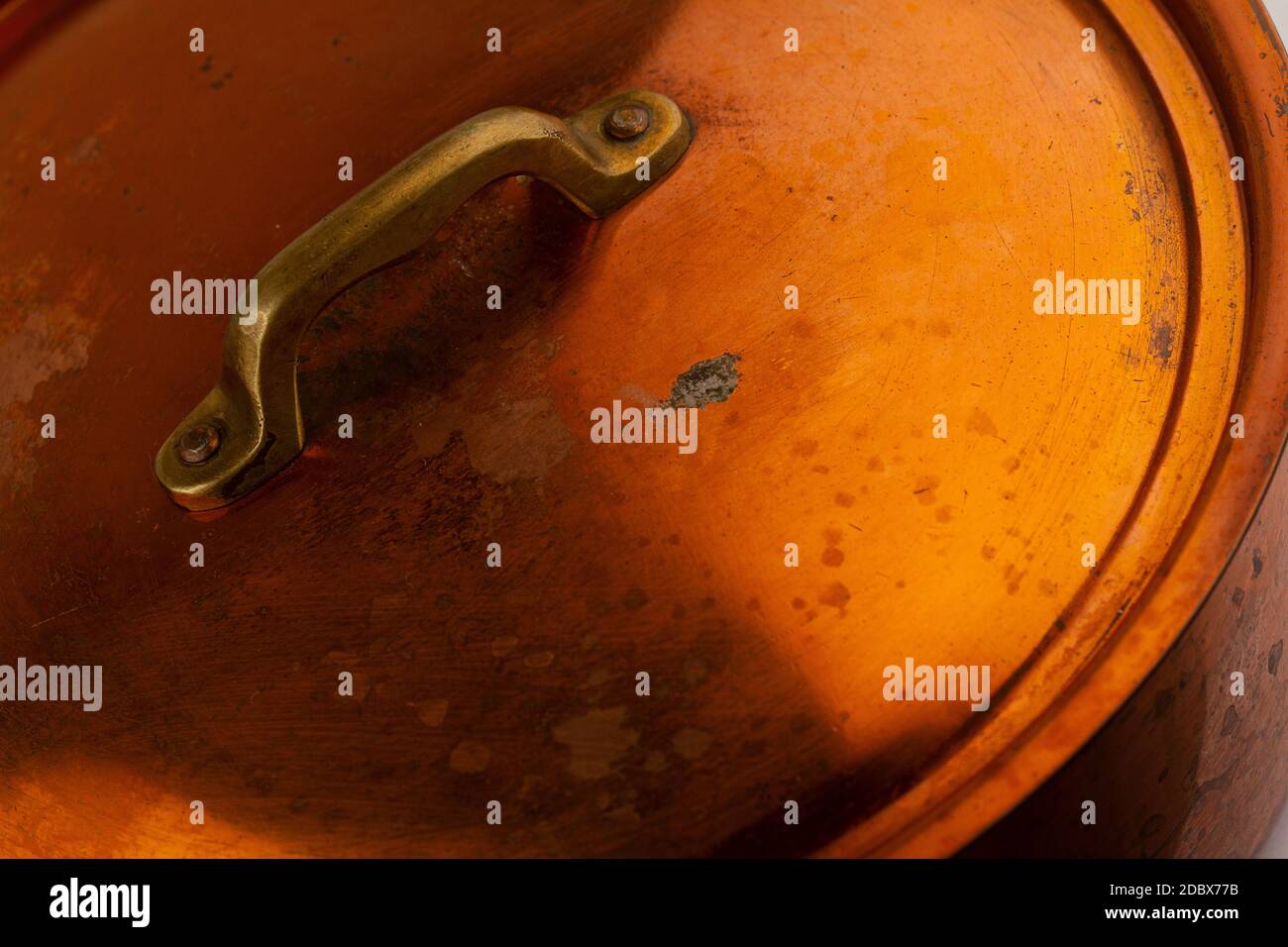 side view closeup detail of old cooking pan with copper lid cover and ...