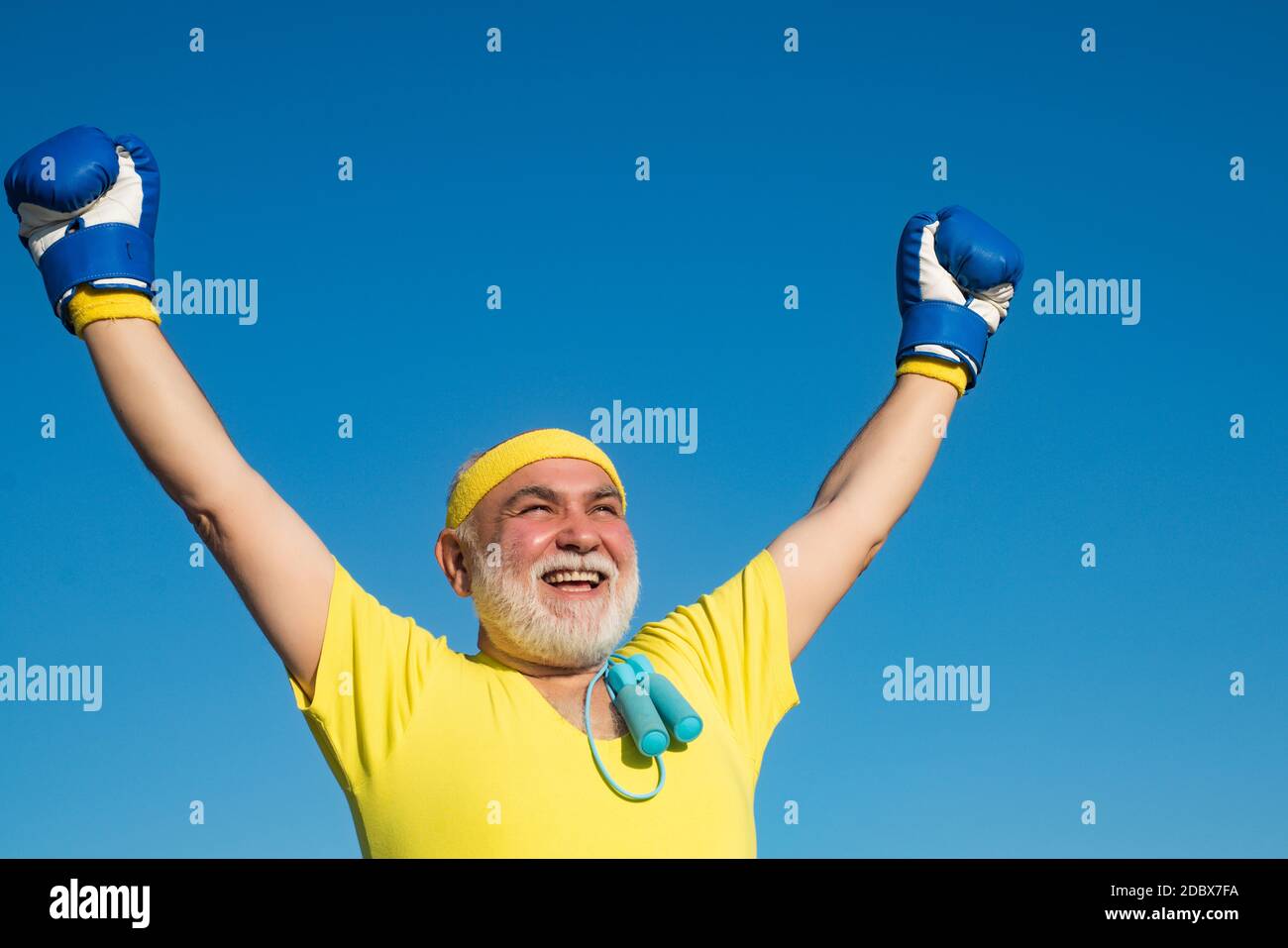 Happy Senior man wearing boxing gloves. Portrait of a determined senior ...