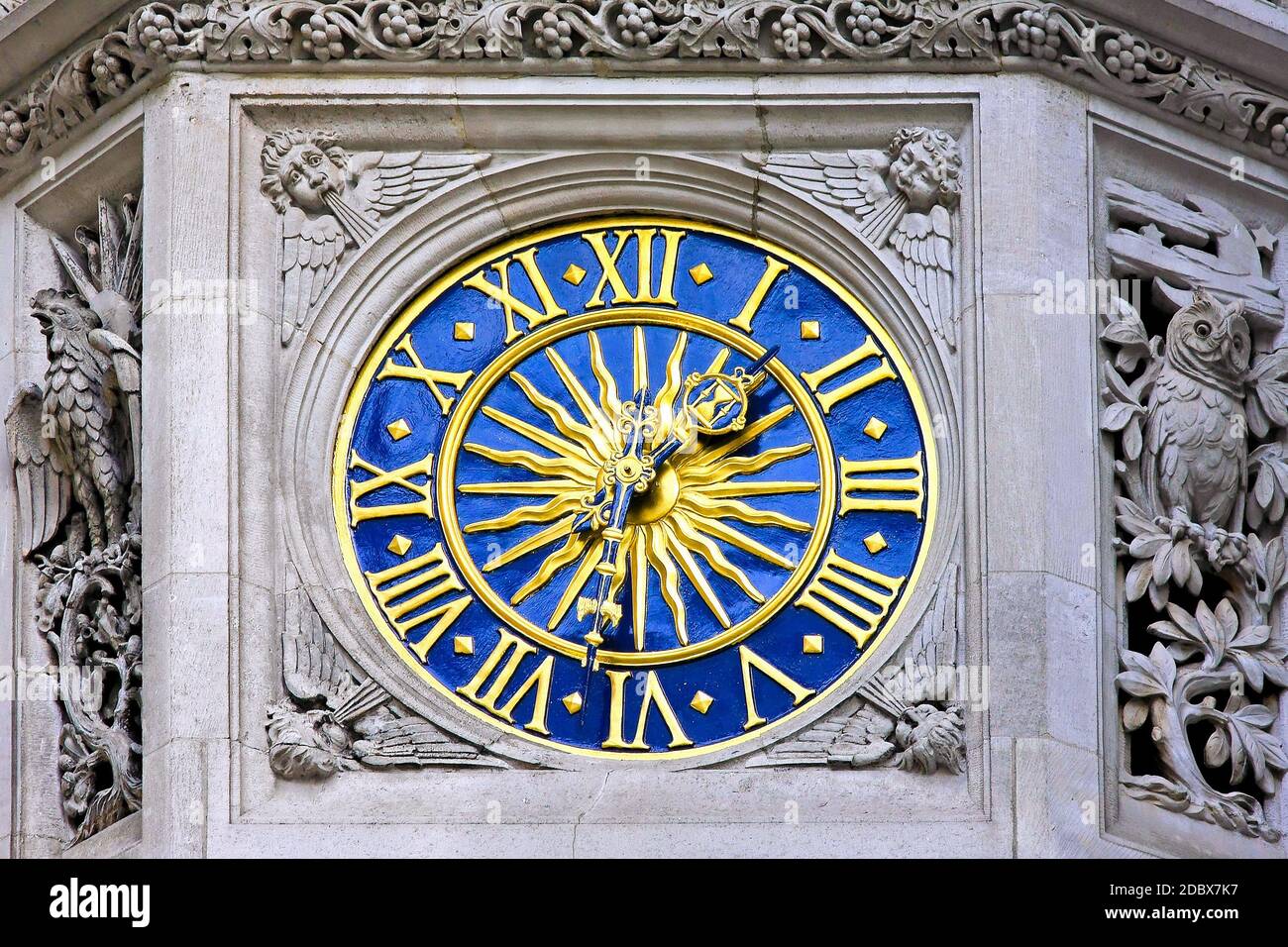 Blue dial clock with golden sun decor Stock Photo - Alamy