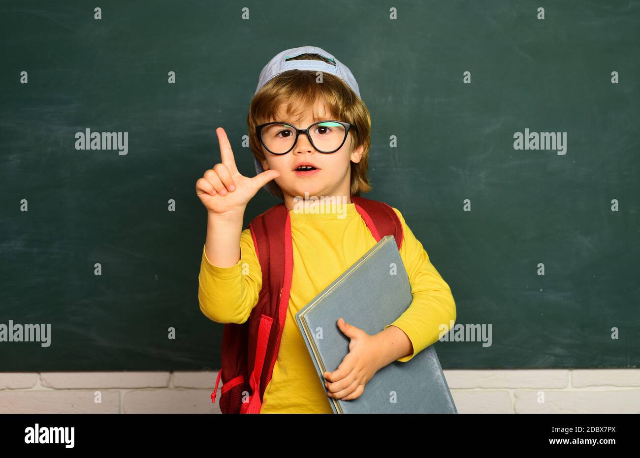 Cute little preschool kid boy in a classroom. Private school. Ready for ...