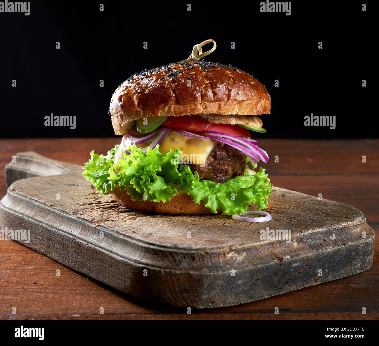 delicious burgers with fried beef cutlet, tomato, lettuce and onions ...