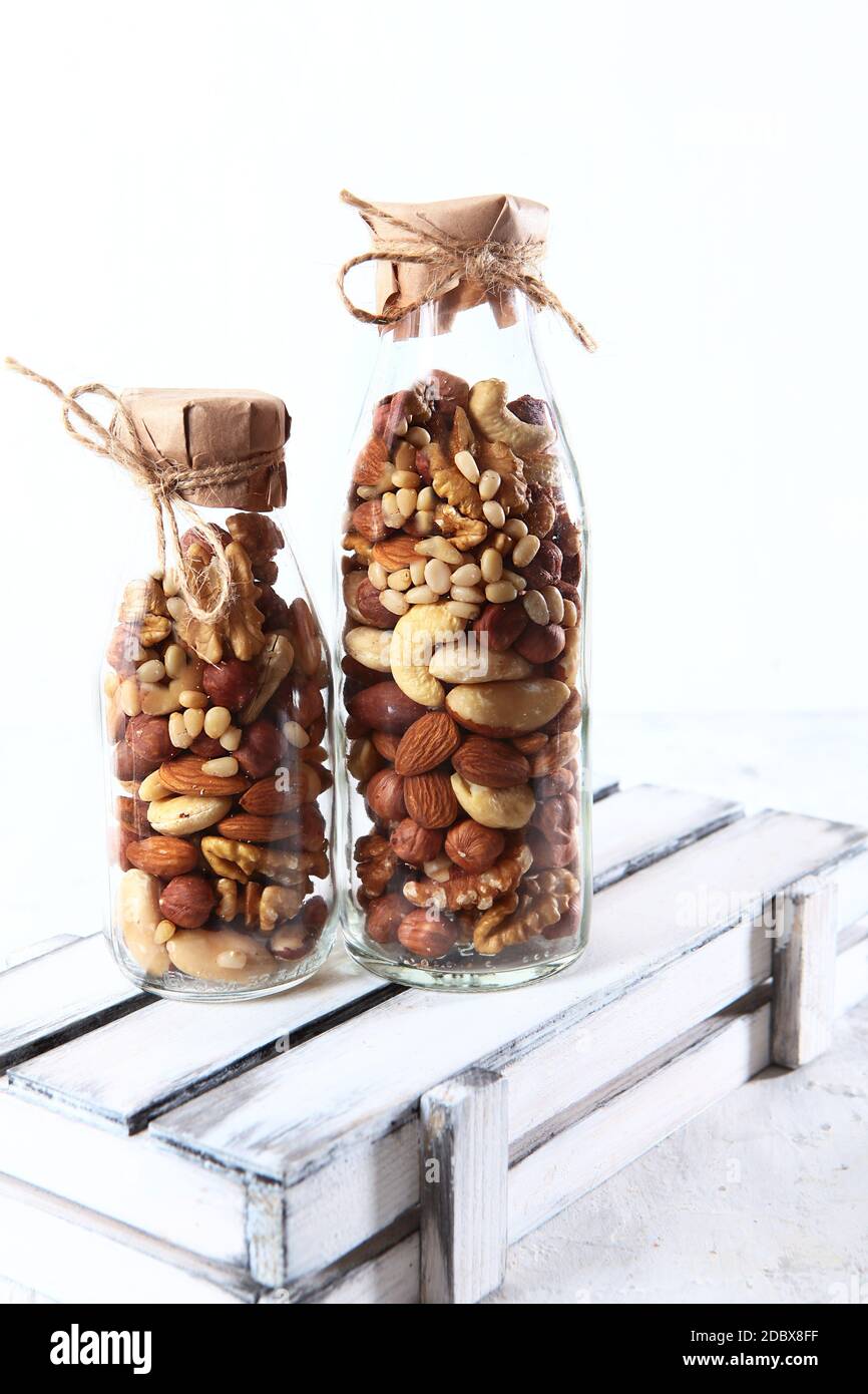 Assorted nuts in glass jars. Two tall jars of nuts. Wholesome food ...