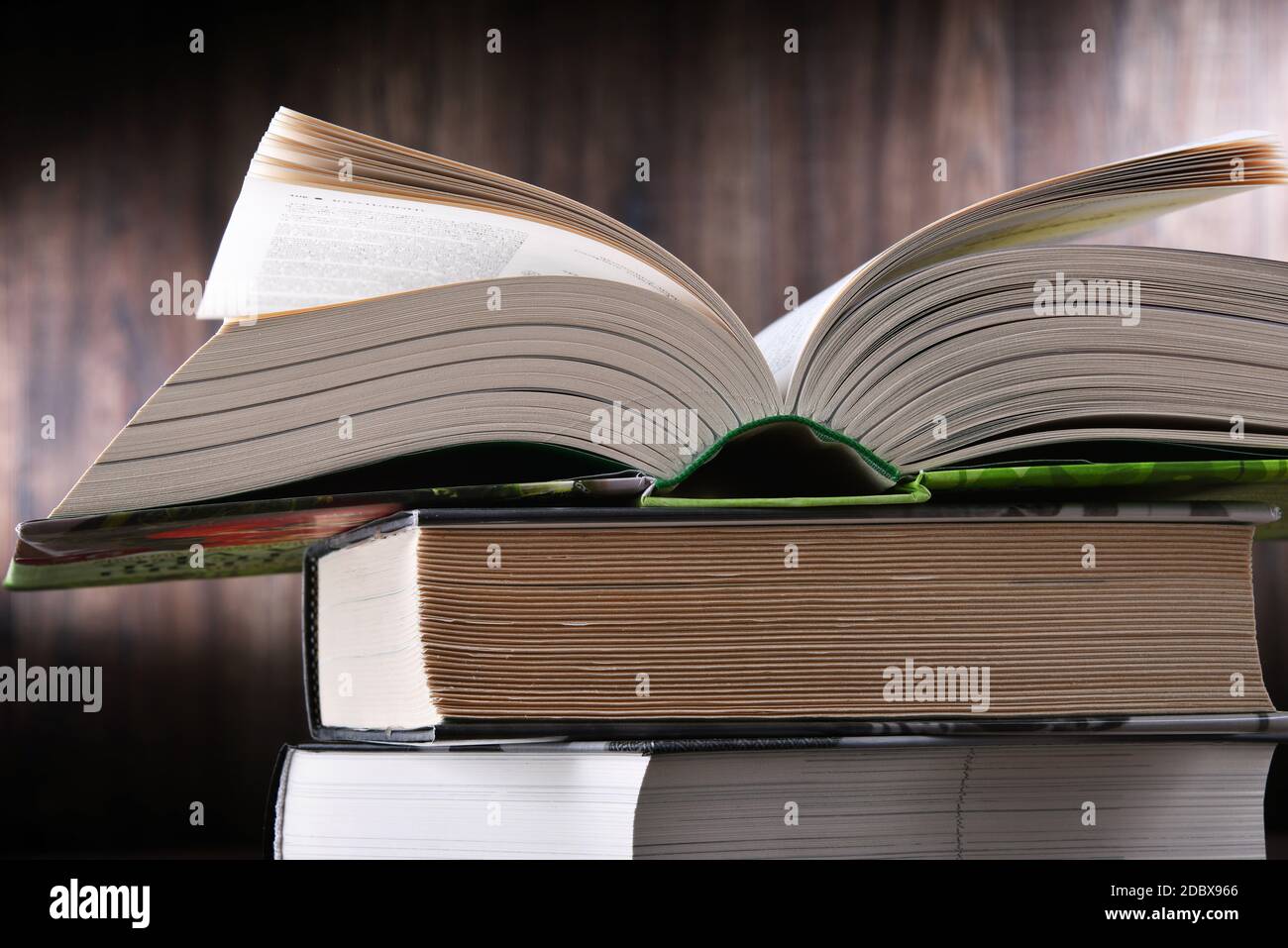 Composition with open book on the table Stock Photo - Alamy