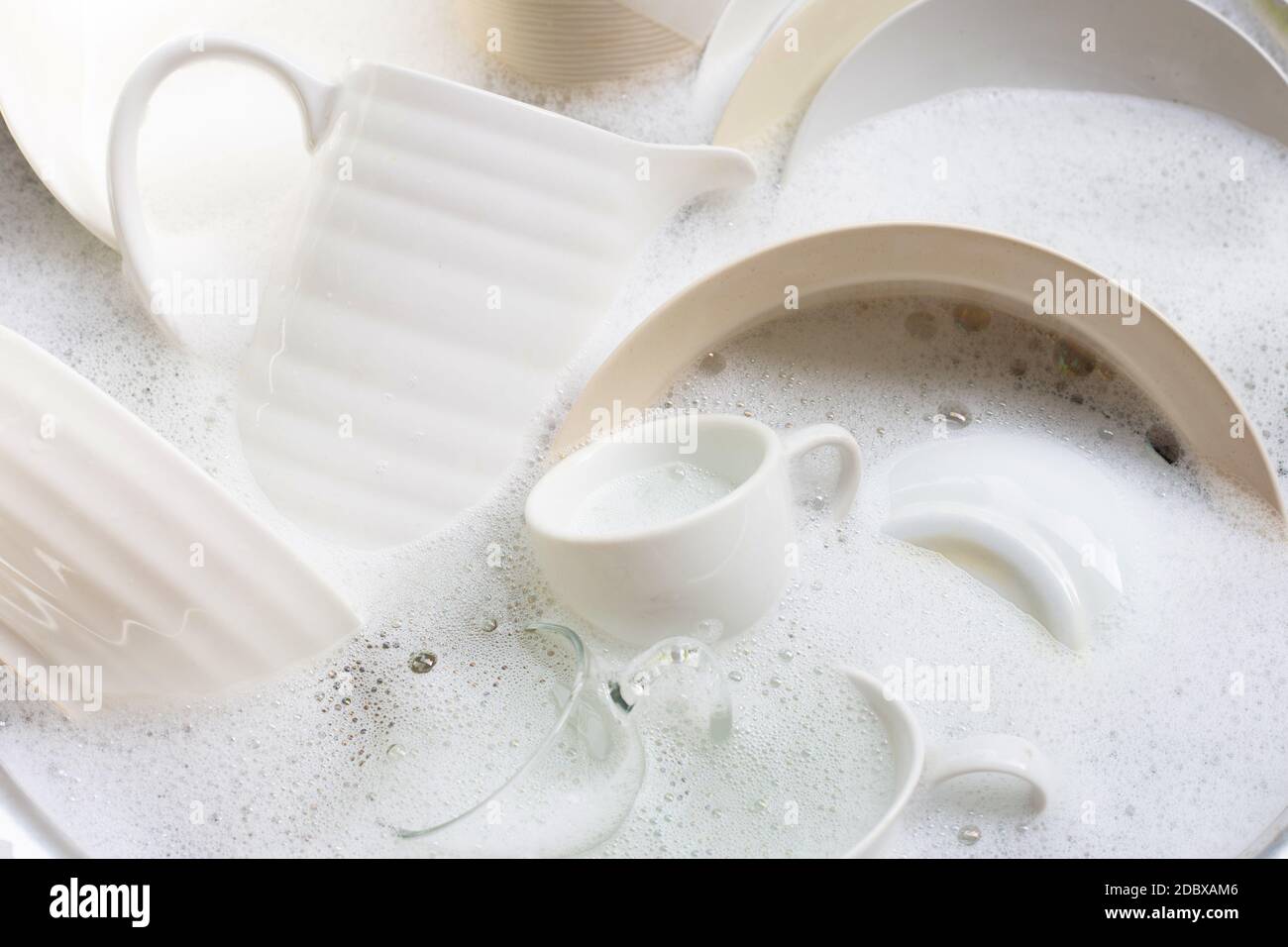 Washing dishes, Close up of utensils soaking in kitchen sink Stock ...