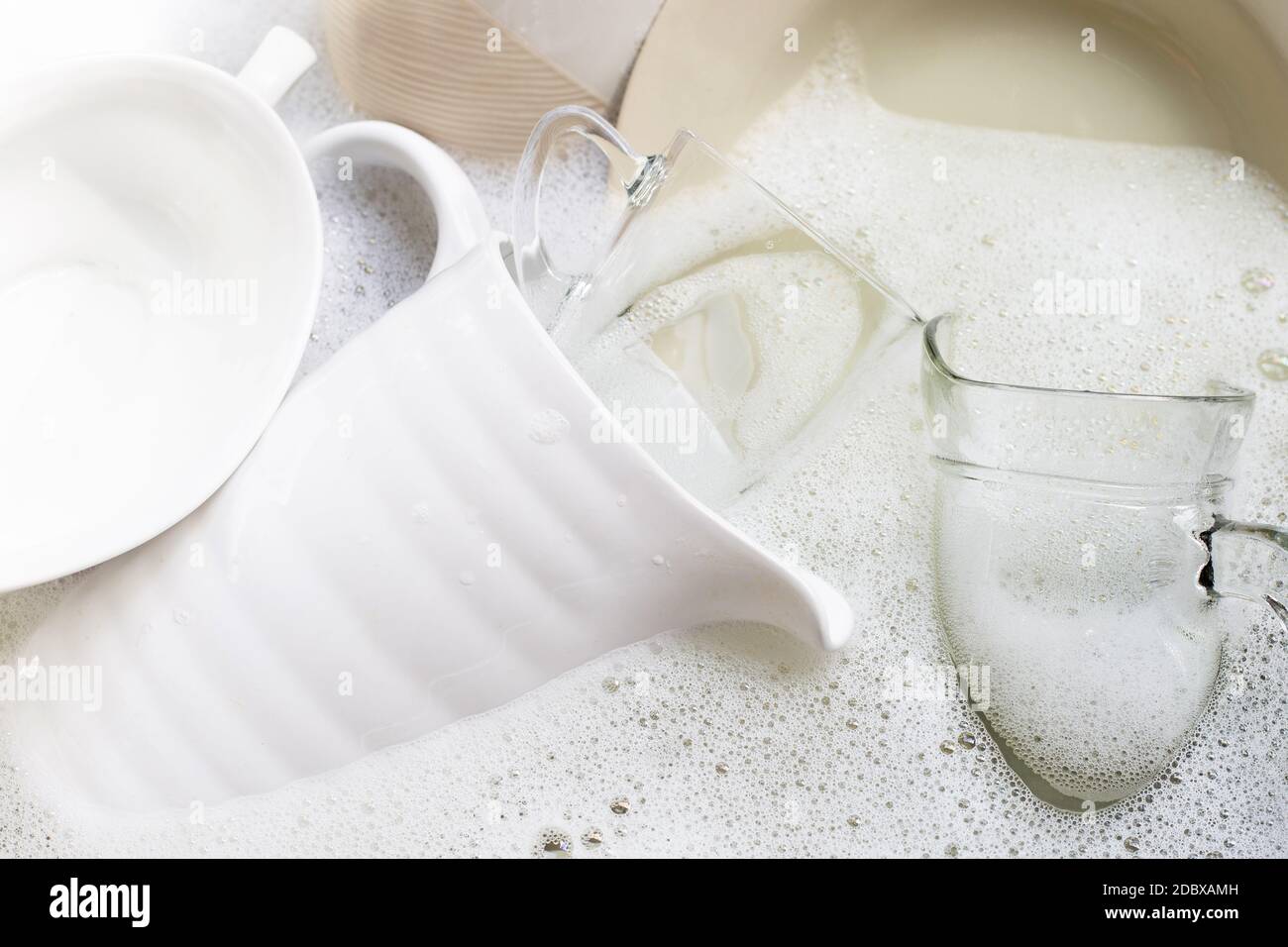 Washing dishes, Close up of utensils soaking in kitchen sink Stock ...
