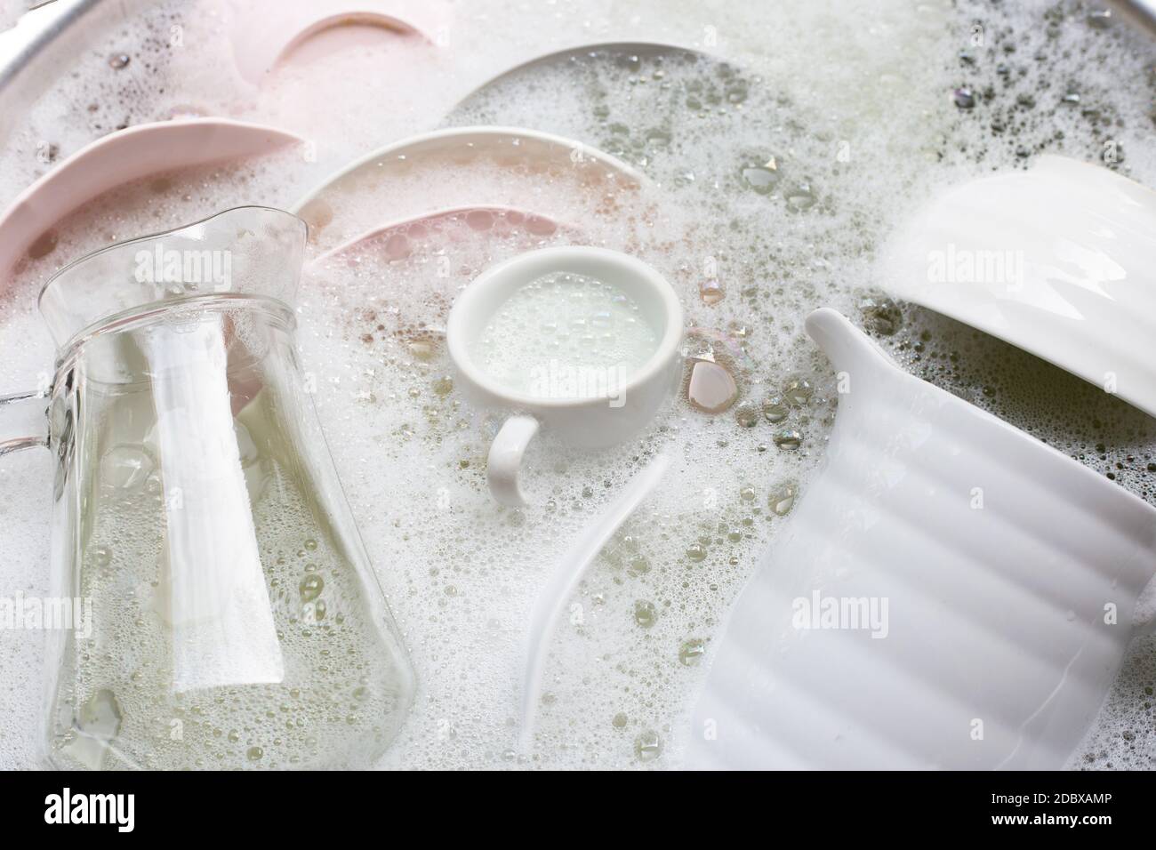 Washing dishes, Close up of utensils soaking in kitchen sink Stock ...