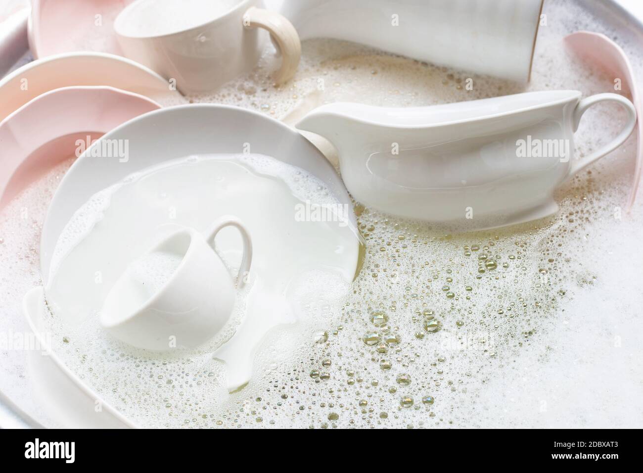 Washing dishes, Close up of utensils soaking in kitchen sink Stock ...