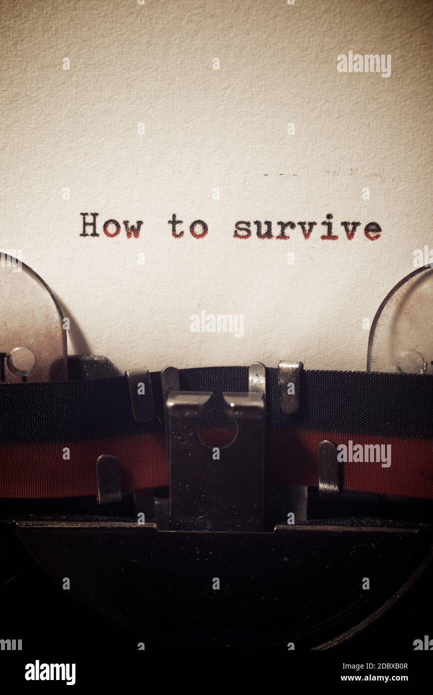 How to survive phrase written with a typewriter Stock Photo - Alamy