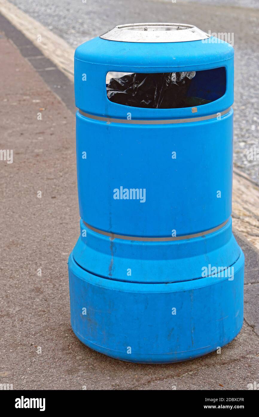 Blue plastic trash can at street Stock Photo - Alamy