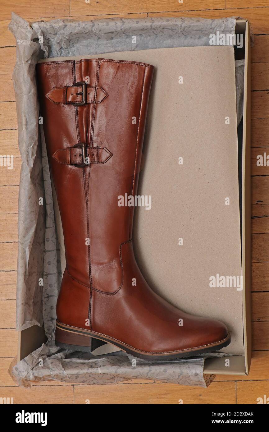 Modern female brown leather boot inside box Stock Photo - Alamy