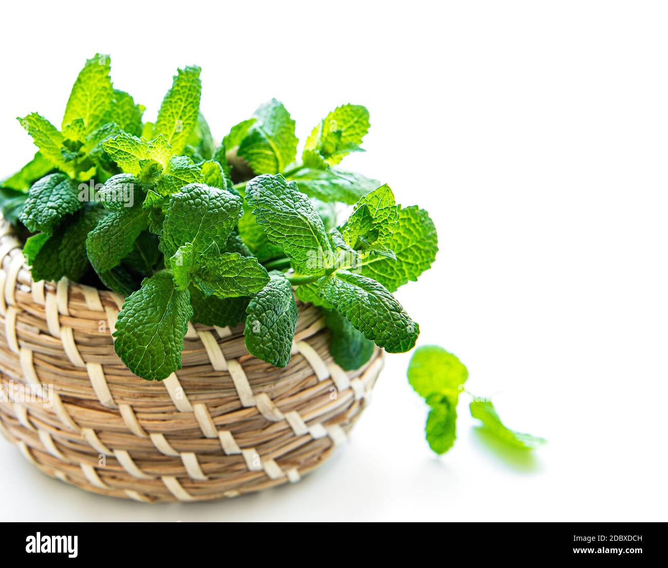 Basket of fresh mint. Isolated on white background Stock Photo - Alamy