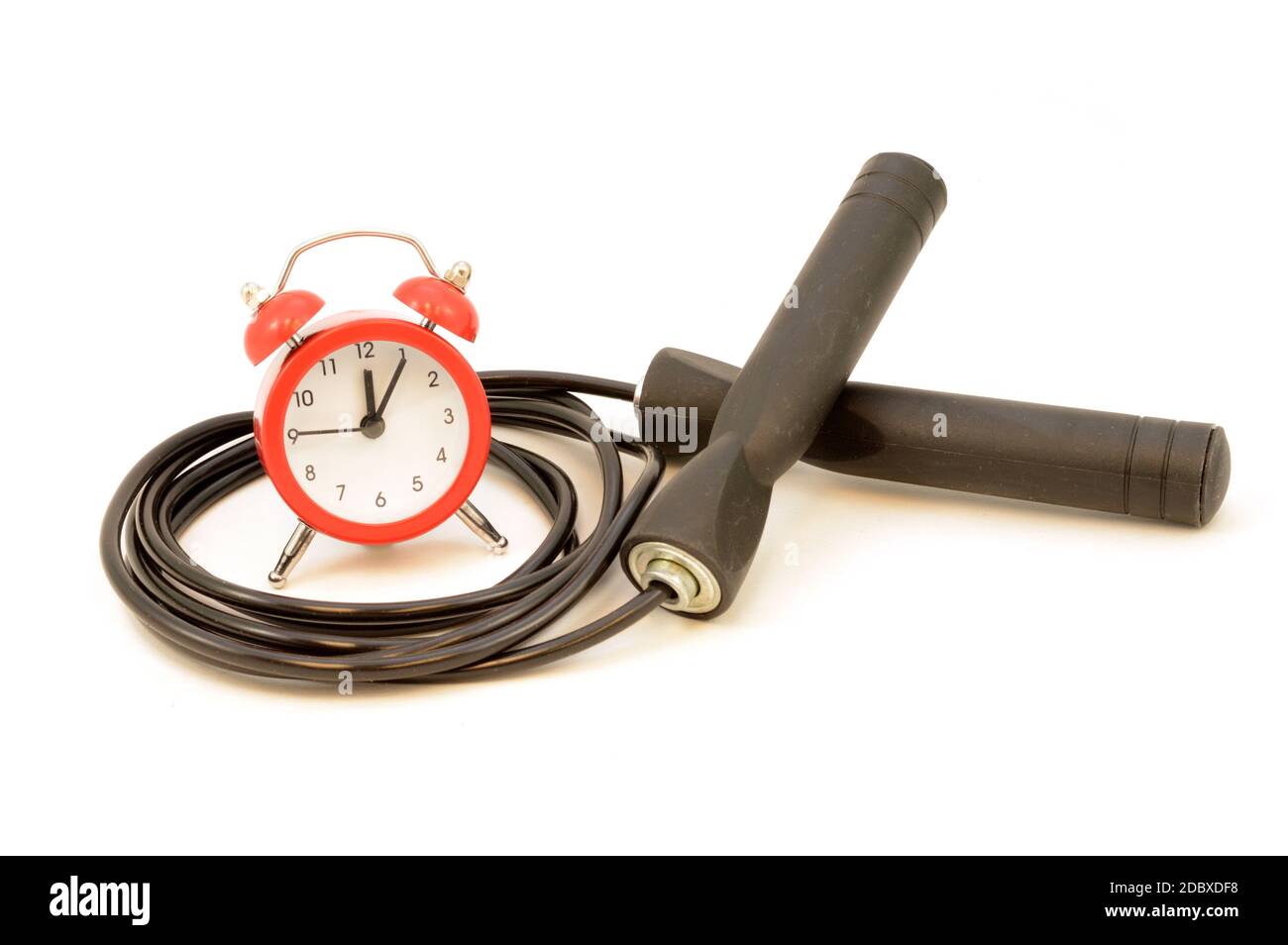 An isolated jump rope for skipping exercises with a red alarm clock ...