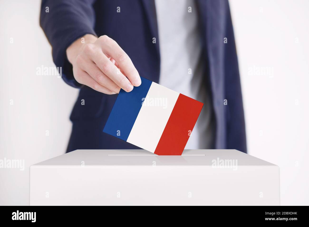 Man putting a ballot with French flag into a voting box Stock Photo - Alamy