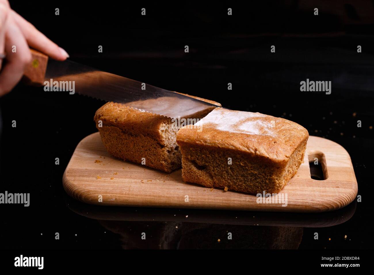 Homemade gray bread on a black background. Photo in section. Cut the ...