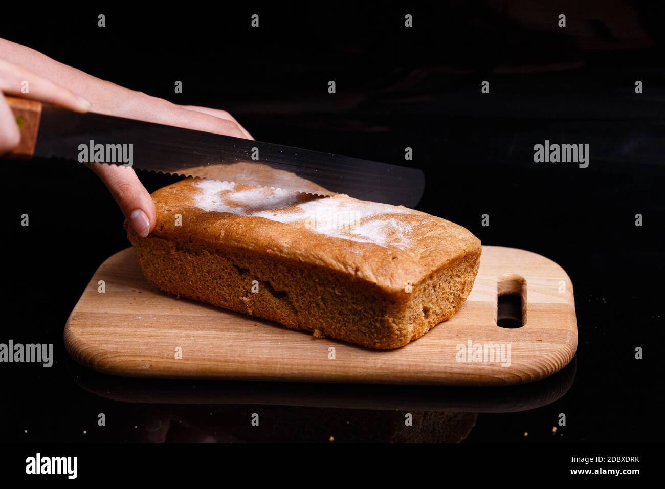 Homemade gray bread on a black background. Photo in section. Cut the ...