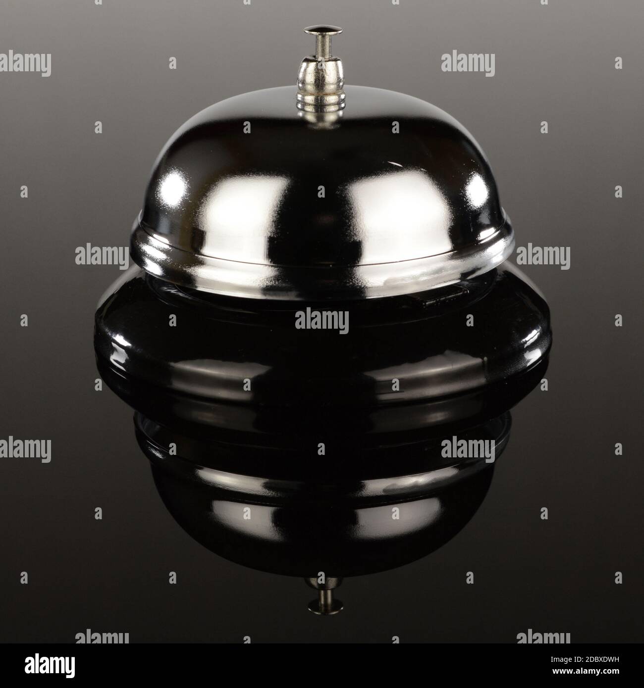 A standard desktop call bell over a gradient reflective surface Stock ...