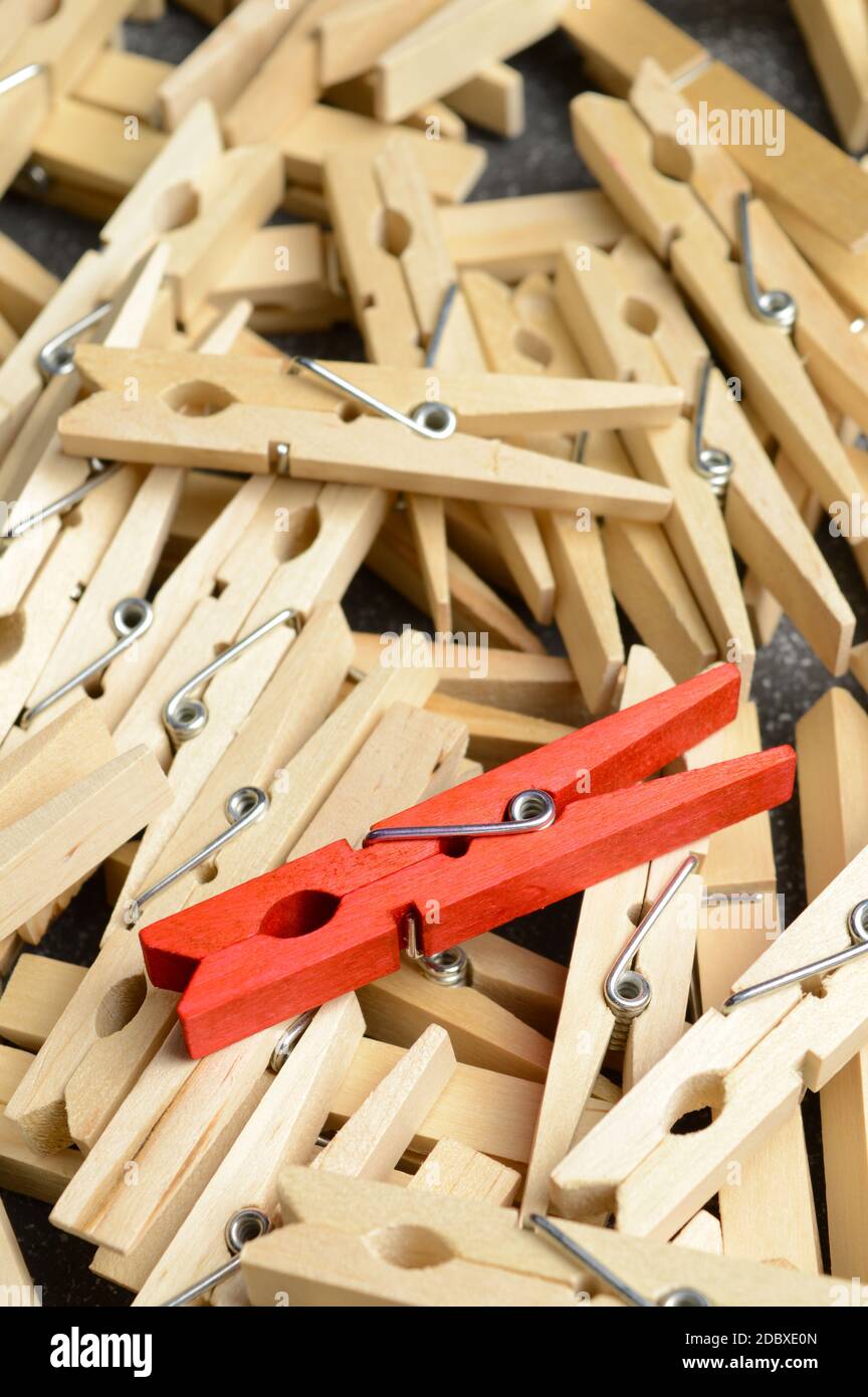 A unique red clothespin stands out from the rest Stock Photo - Alamy