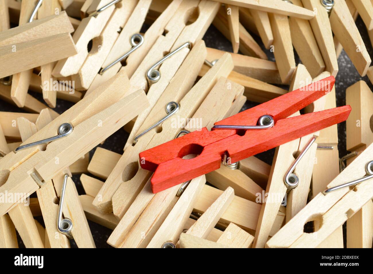 A unique red clothespin stands out from the rest Stock Photo - Alamy