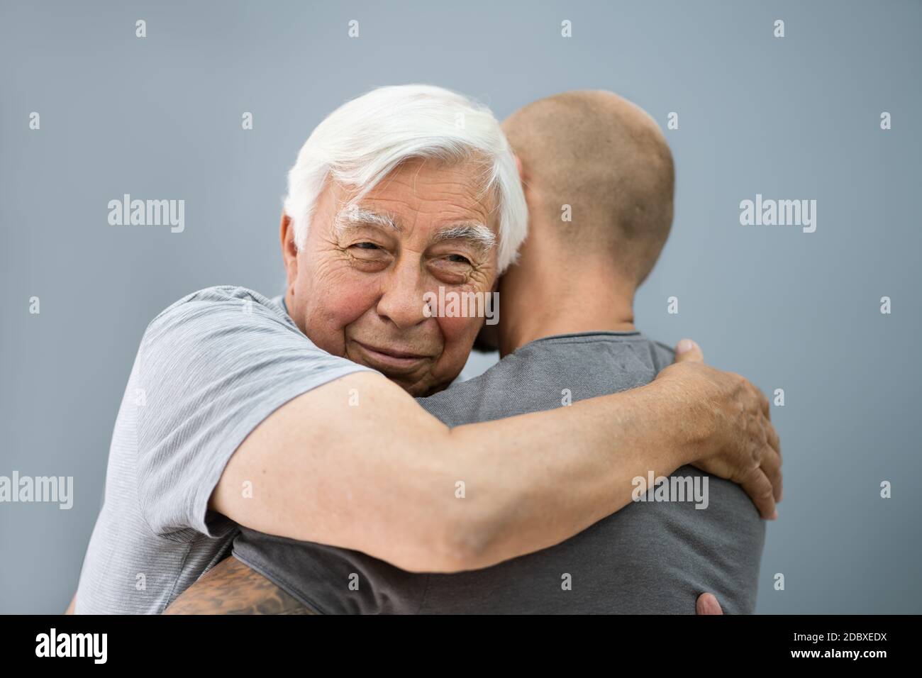 Son Hugging His Happy Grandfather Indoors. Family Together Stock Photo ...