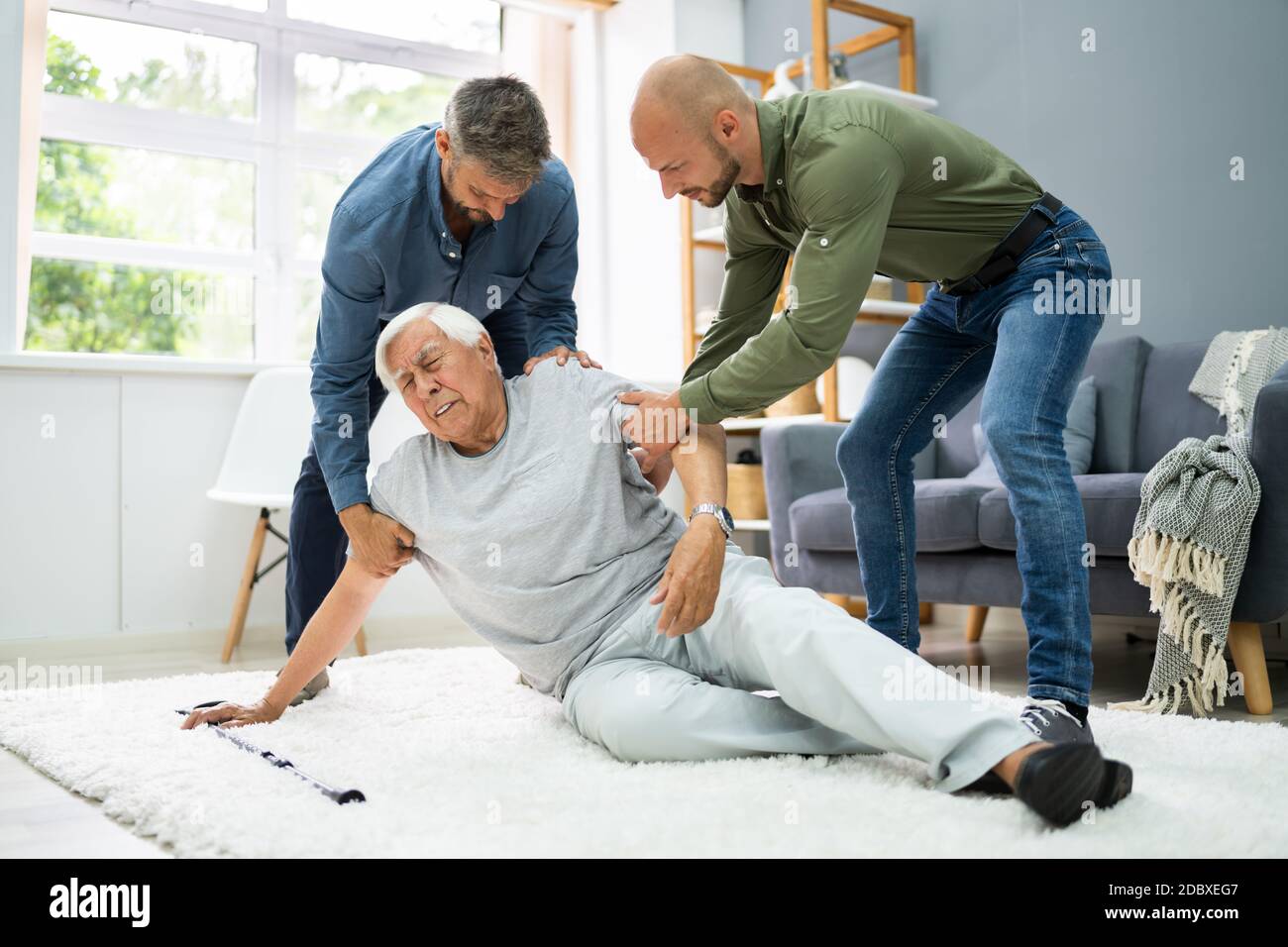 Helping Elder Senior Fallen Man After Fall Accident Stock Photo - Alamy