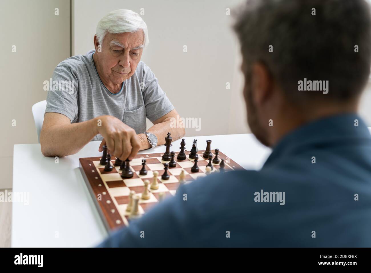 Elderly Senior Playing Chess Table Board Game Stock Photo - Alamy