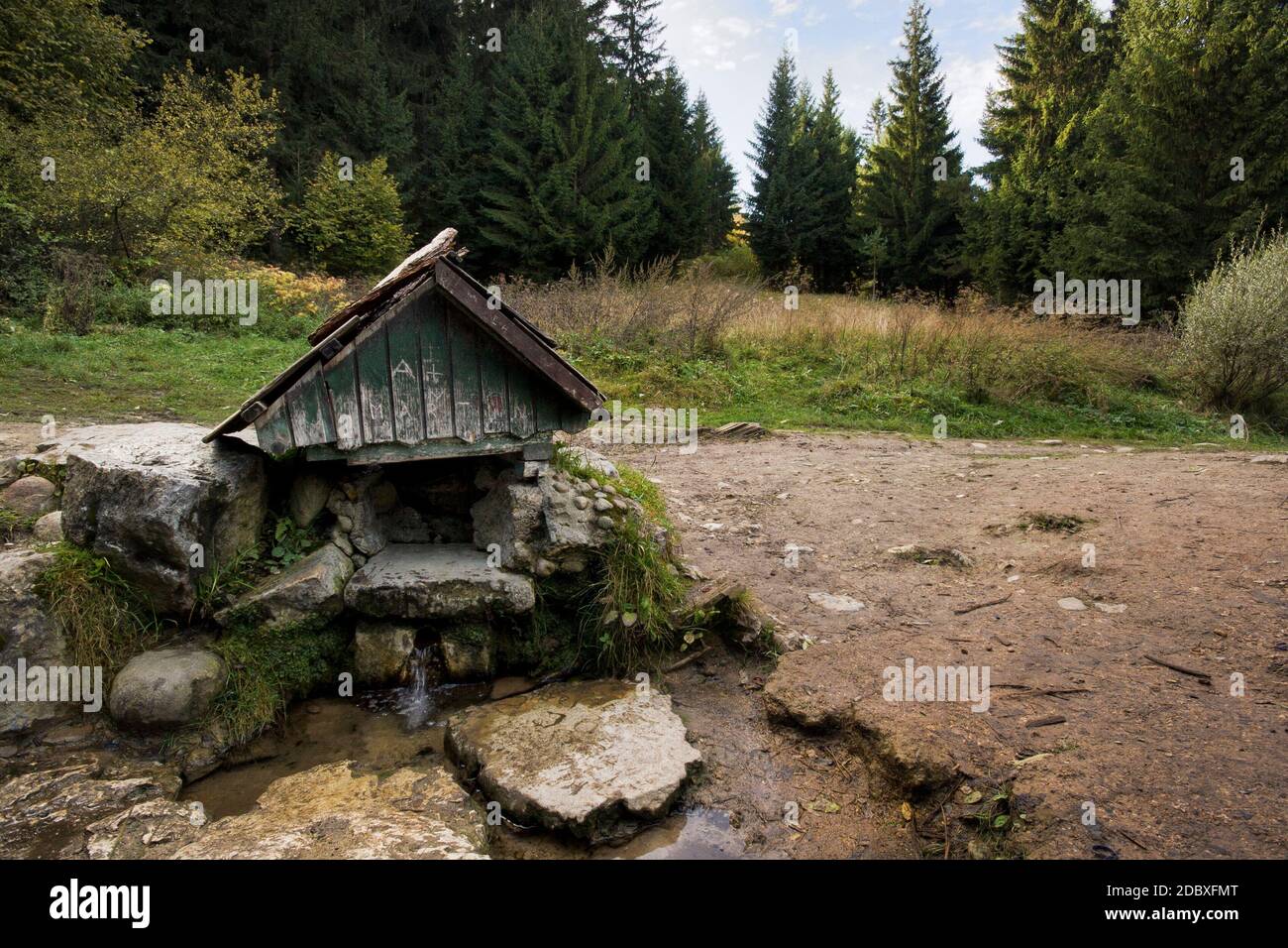 mineral spring covered with small wooden roof during summer, Liptov ...