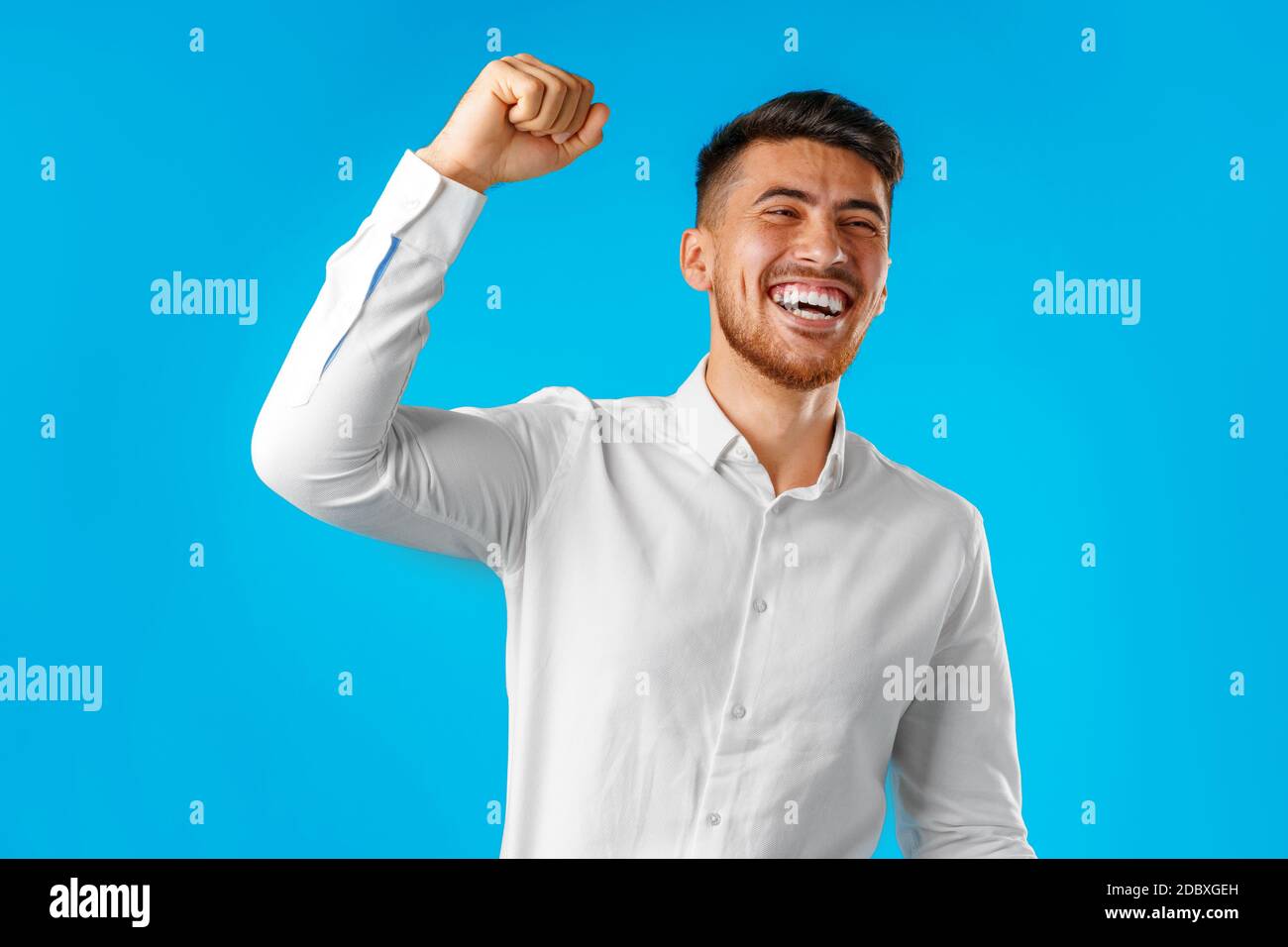 Portrait of excited, successful man raising hands up Stock Photo - Alamy