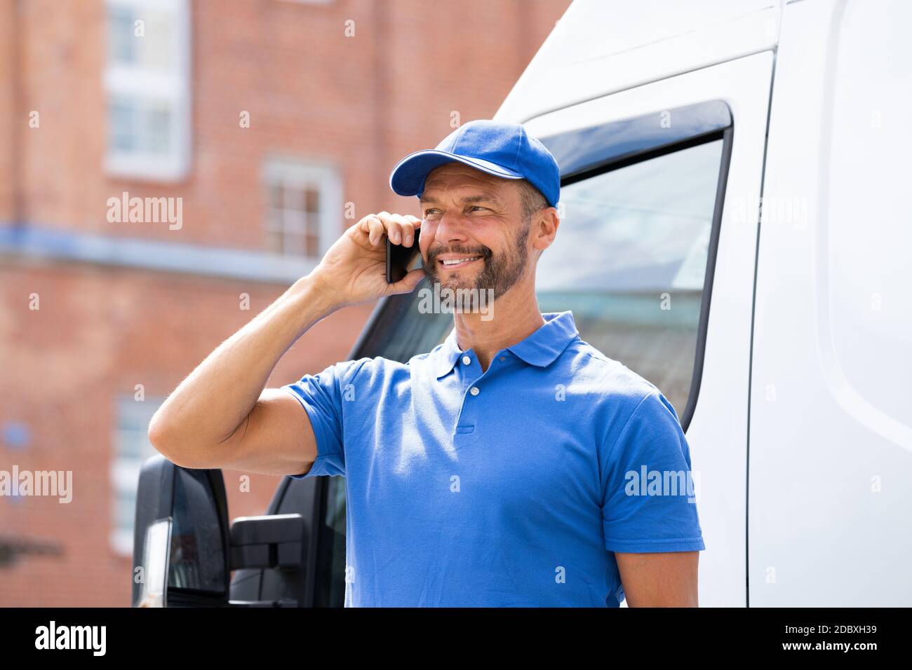 Handyman Men Talking On Mobile Phone Near Truck Or Van Stock Photo - Alamy