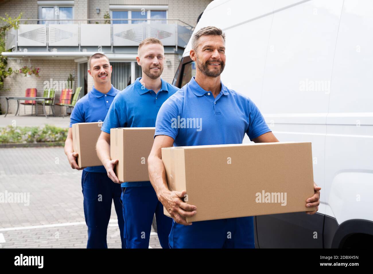Truck Movers Loading Van Carrying Boxes And Moving House Stock Photo ...
