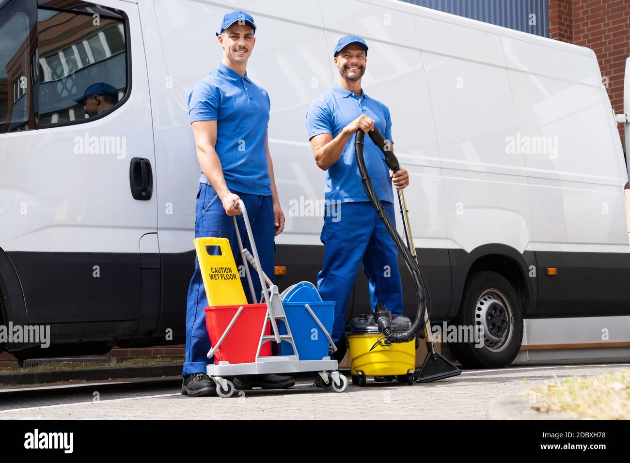 Guy With Vacuum Cleaner And Worker Near Truck Stock Photo - Alamy