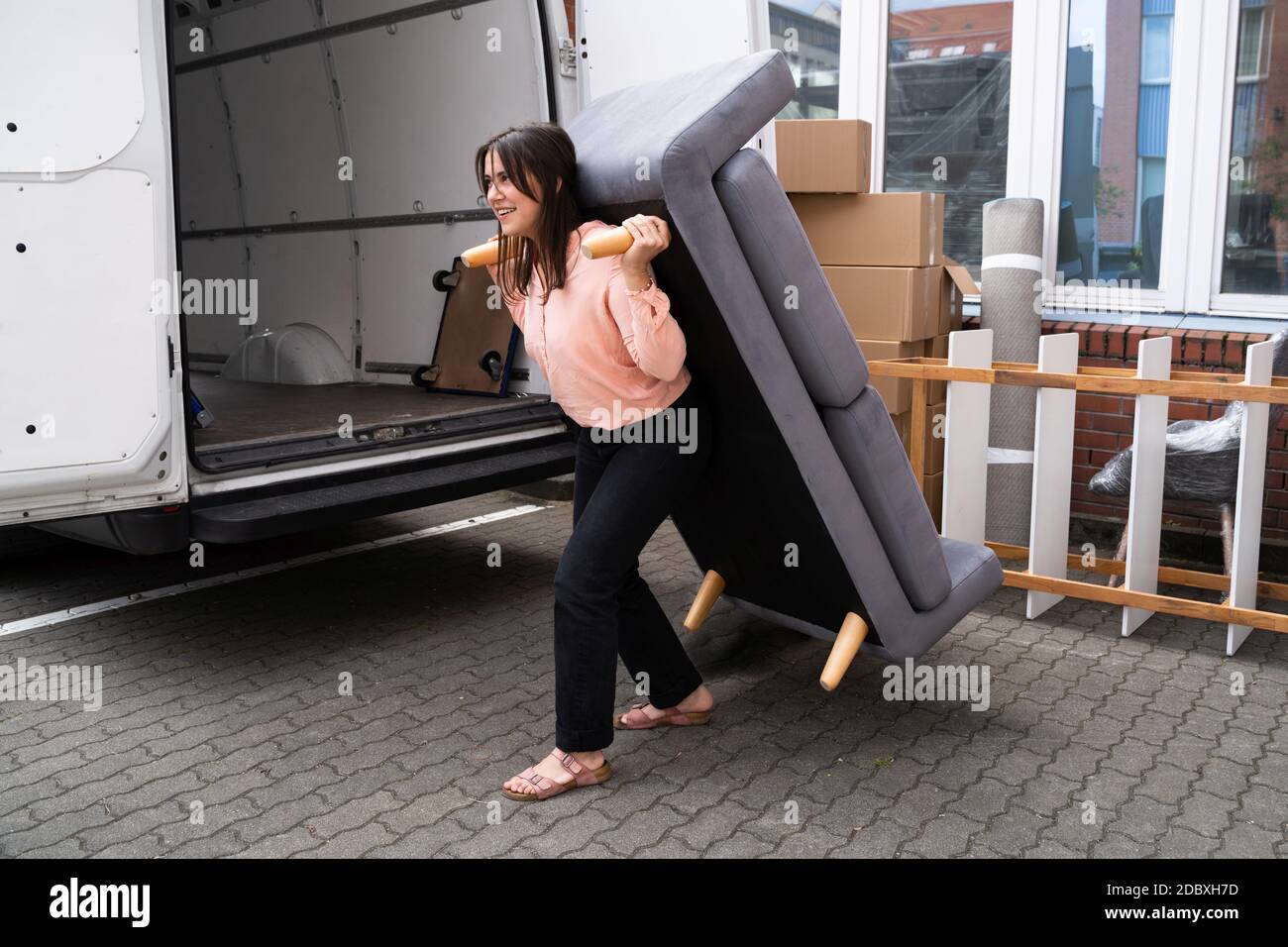 Woman Moving New Sofa Furniture From Truck Stock Photo - Alamy