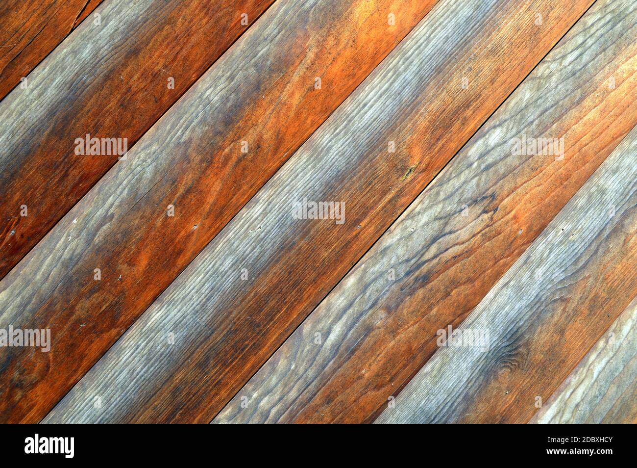 Wooden wall made of diagonal boards with white painted spots ...