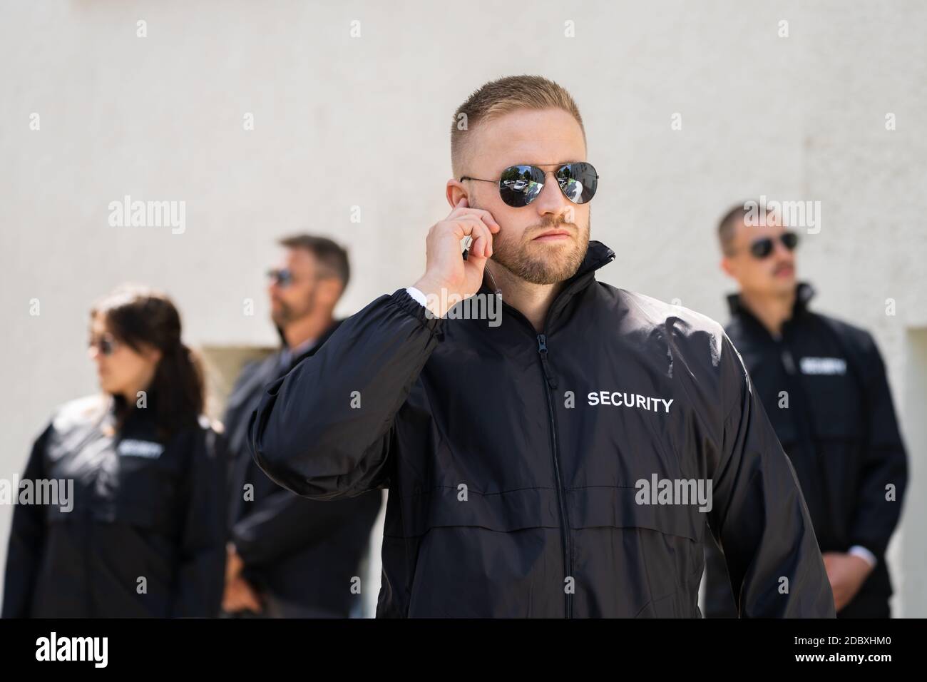 Security Guard Event Service. Officer And His Group Stock Photo - Alamy
