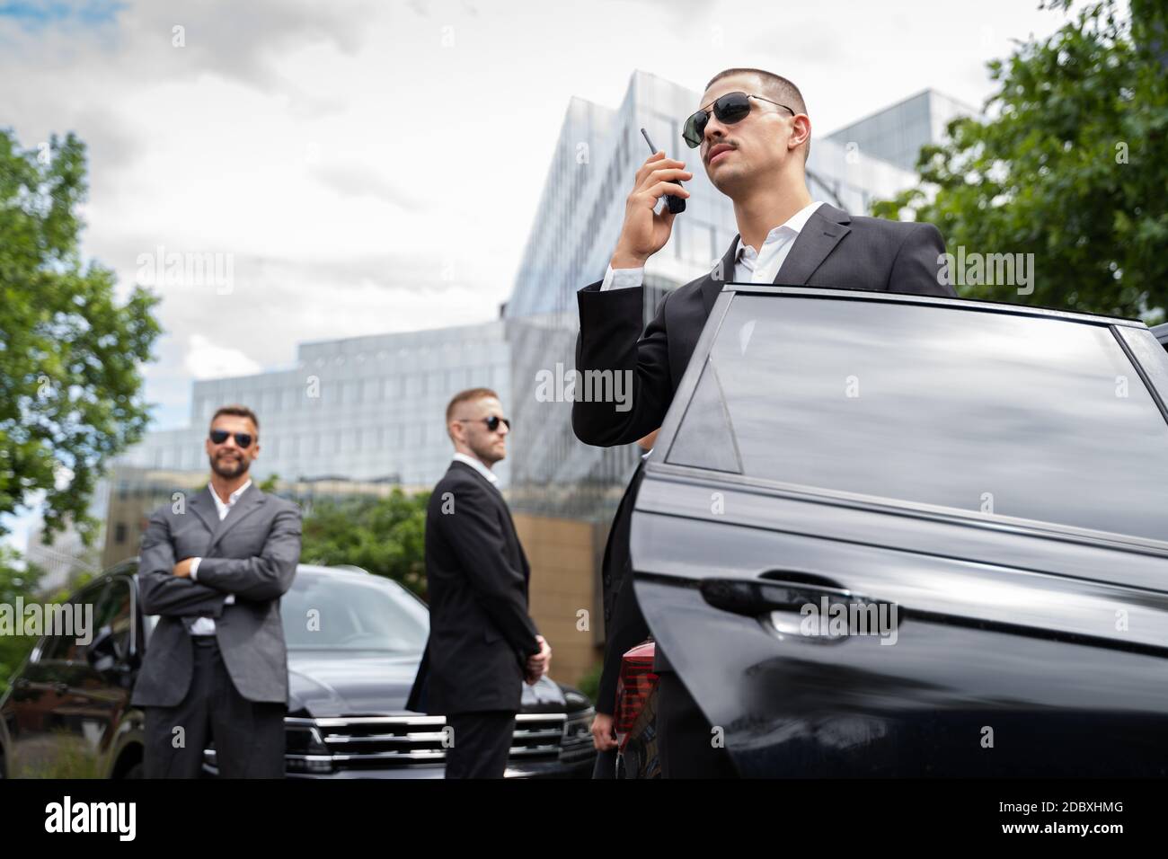 Business Security Guard Service At Work Near Luxury Car Stock Photo - Alamy