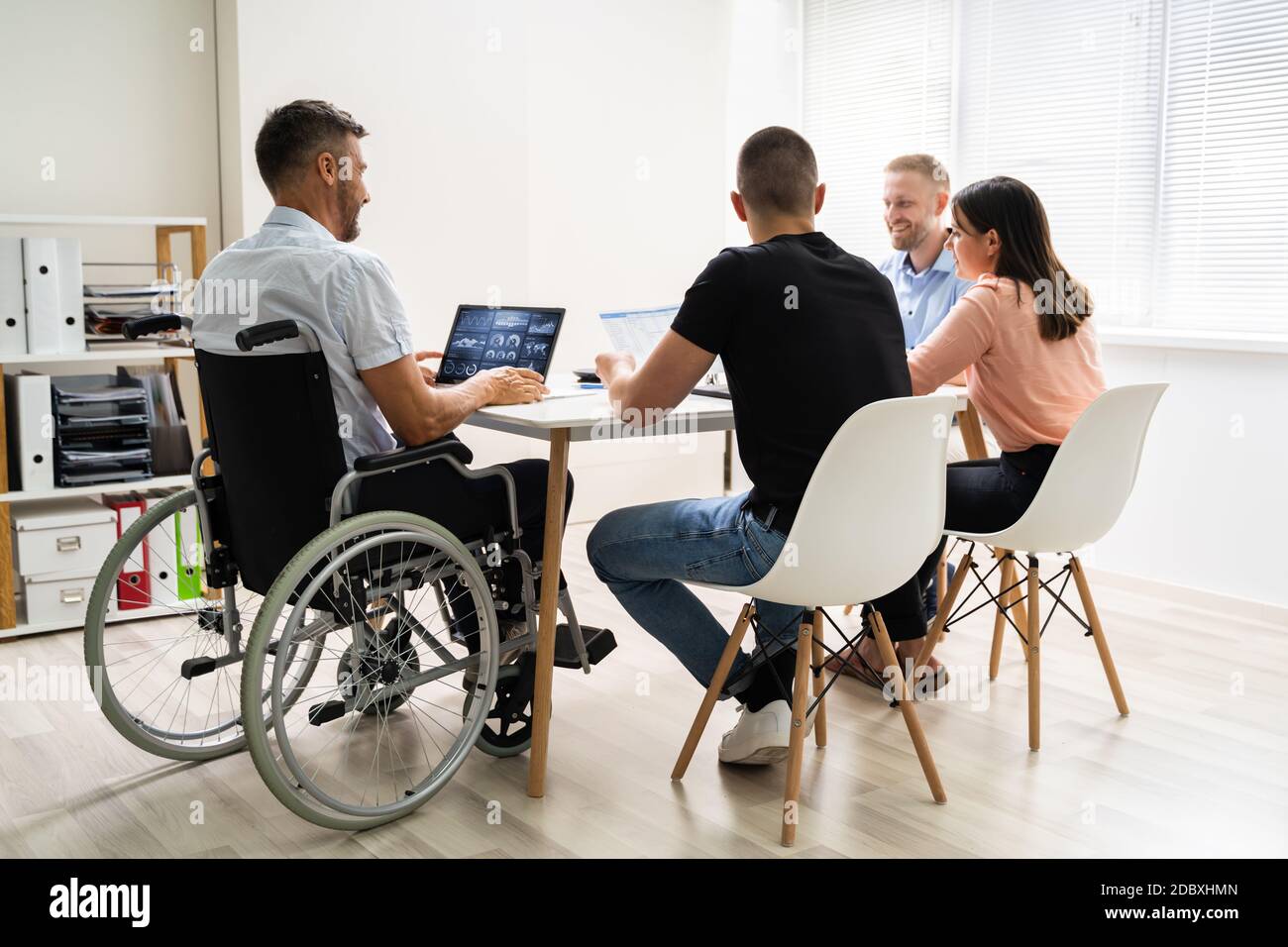 Disabled People In Wheelchair At Workplace Business Meeting Stock Photo ...