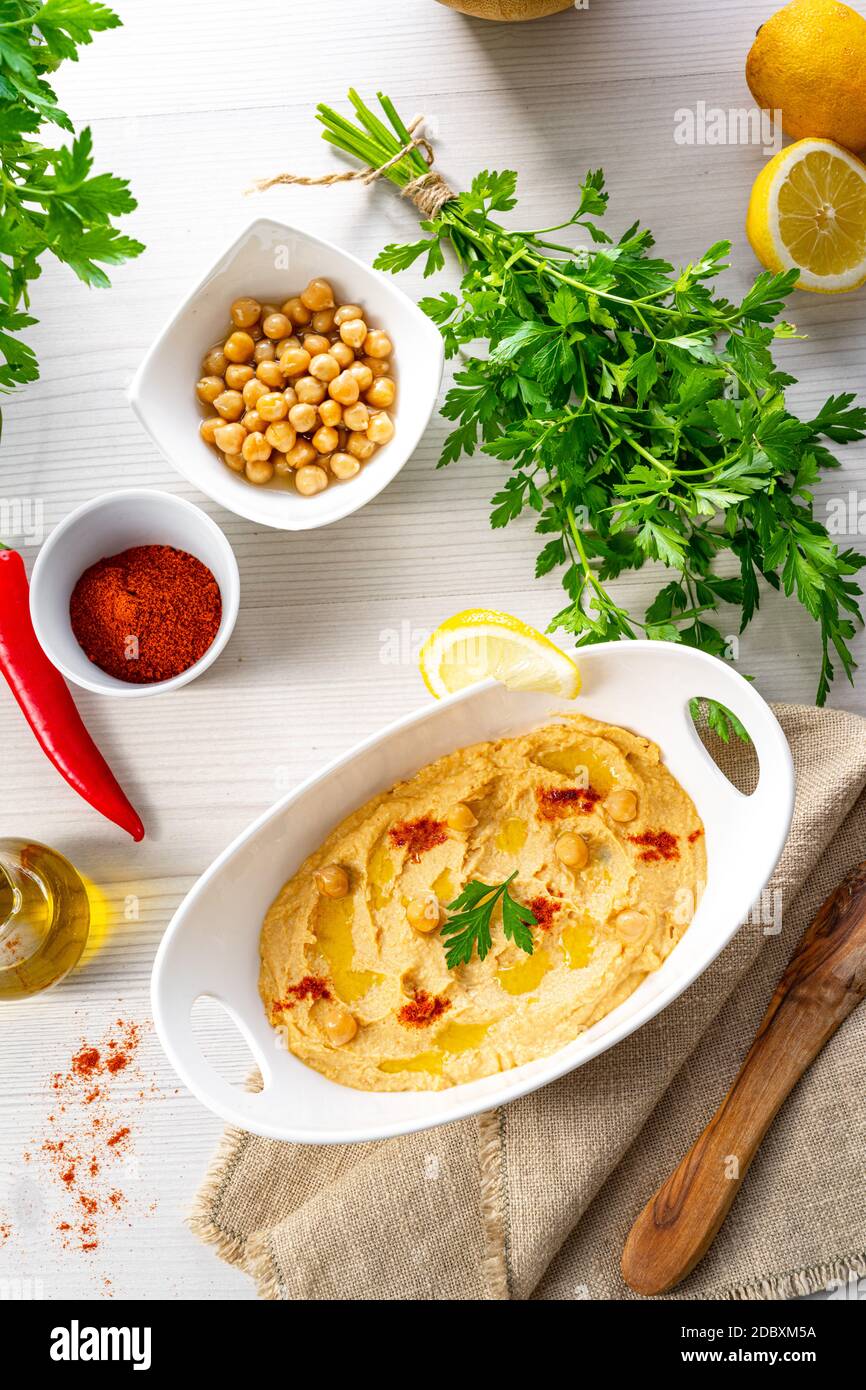 hummus paste with lemon and chilli on white background Stock Photo - Alamy